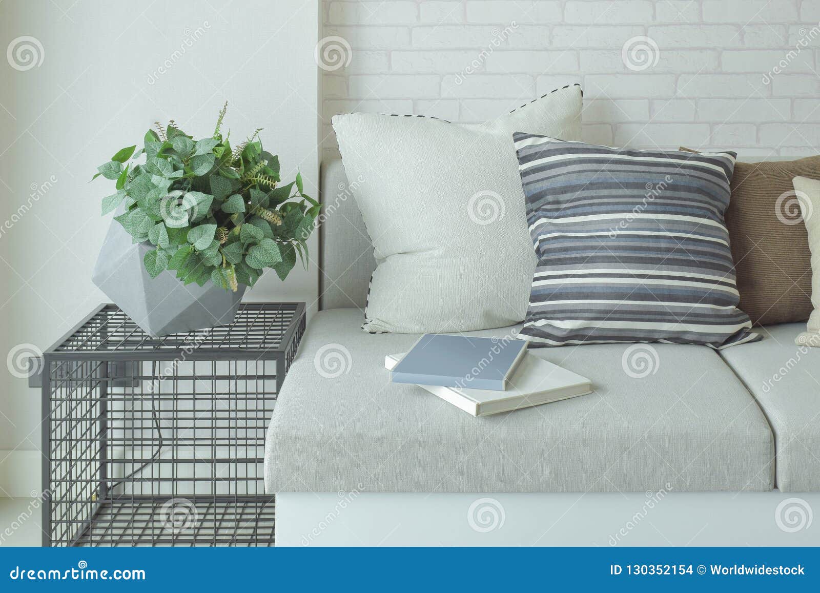 Books on Sofa with Flower Pot on Side Table Stock Photo - Image of ...