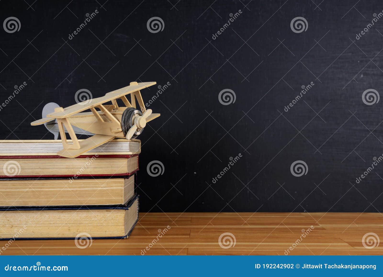 The Books that are Stacked and Plane Model Placed on the Table Stock ...