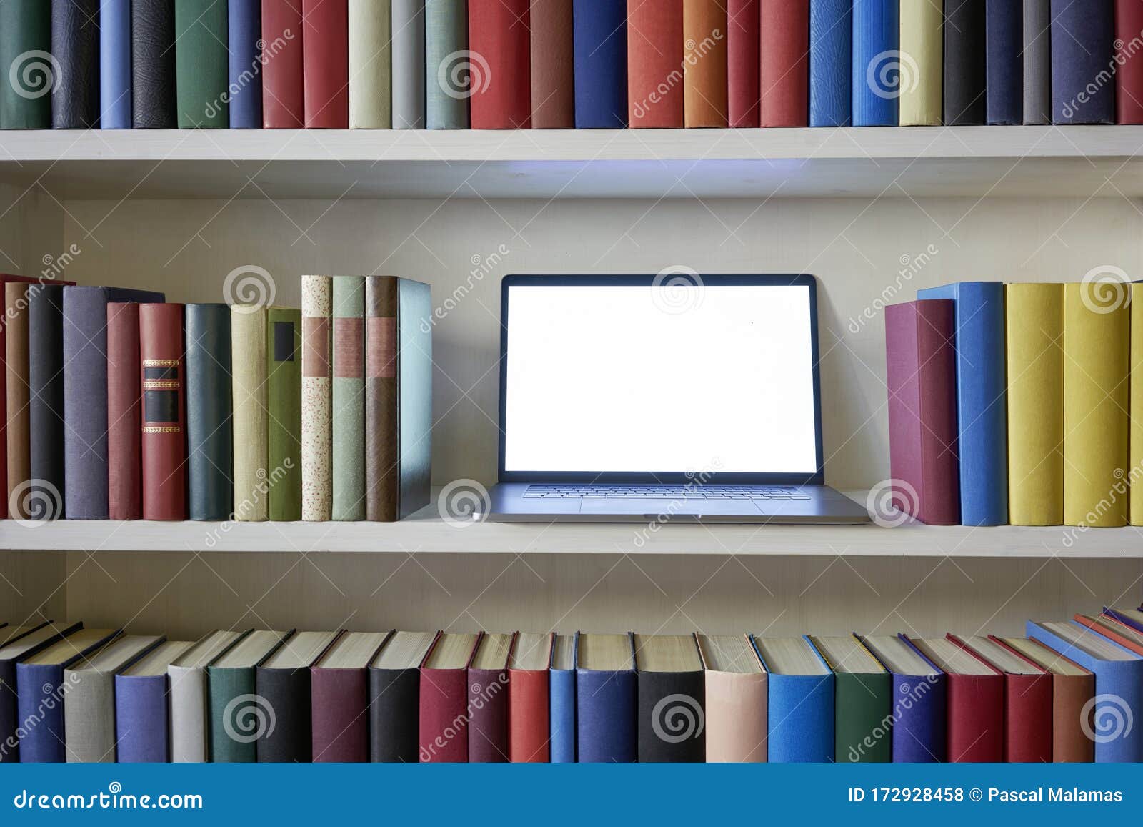 Bookshelf with laptop stock photo. Image of academy - 172928458