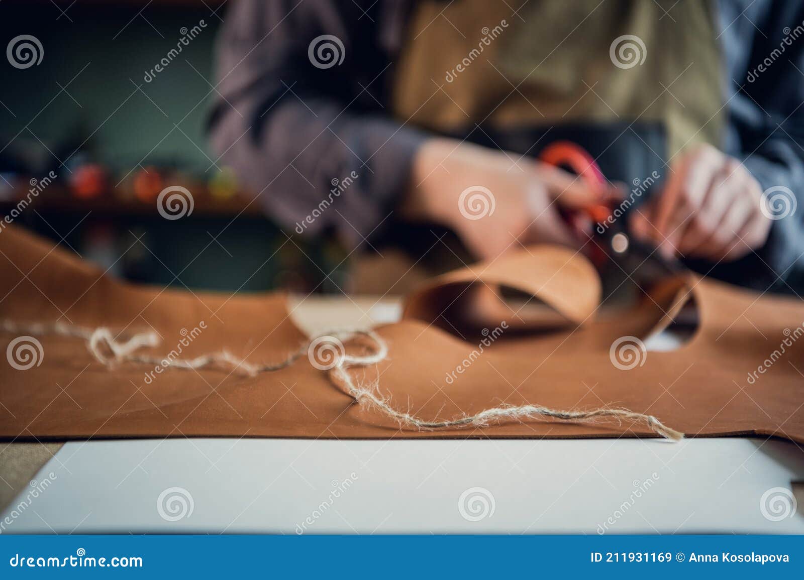 In a Boot Shop, an Experienced Young Master Cuts Out Leather Shoe ...