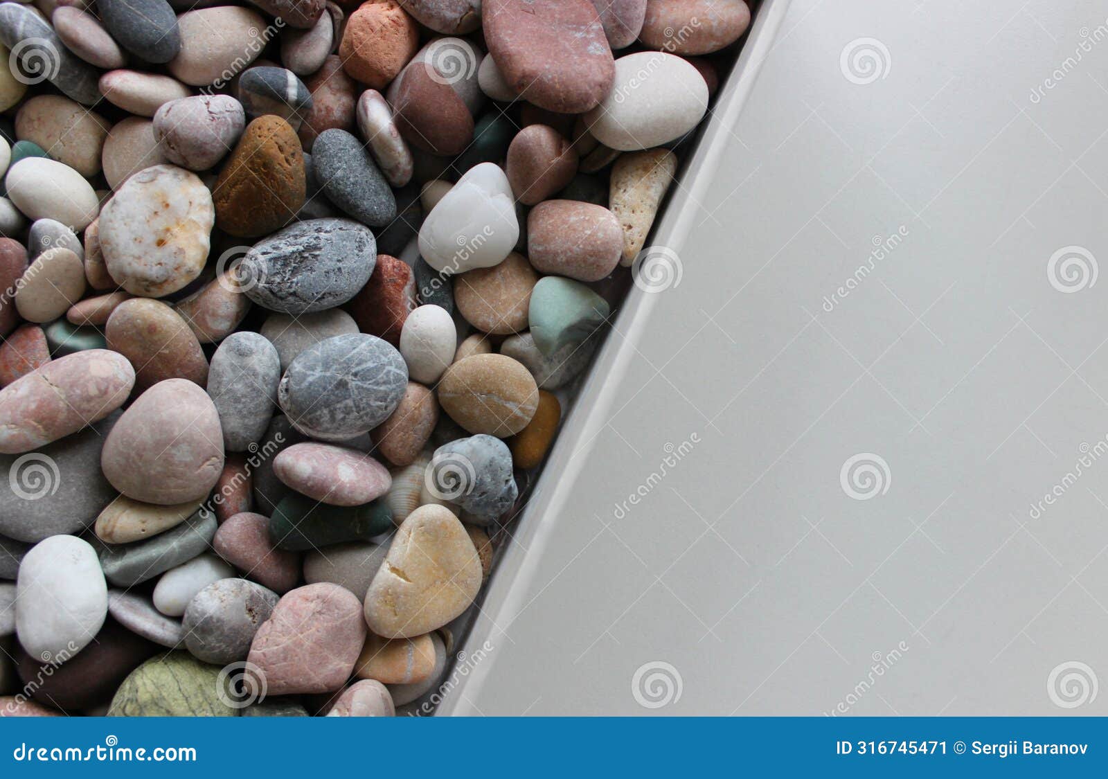 Colored Pebbles and River Rocks in a Cardboard Box on White Surface Top ...
