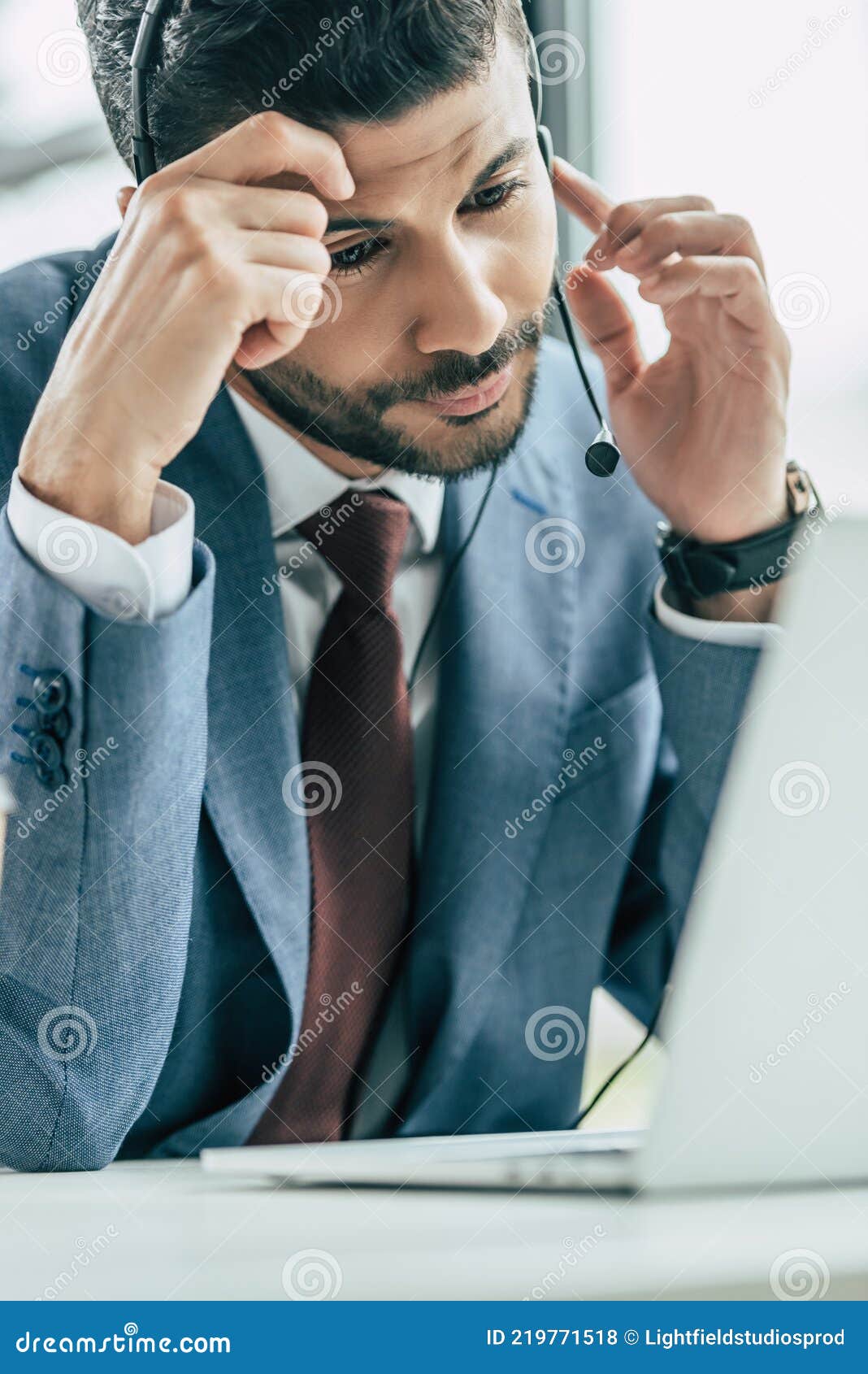 Bored Call Center Operator in Headset Looking at Laptop while Sitting ...