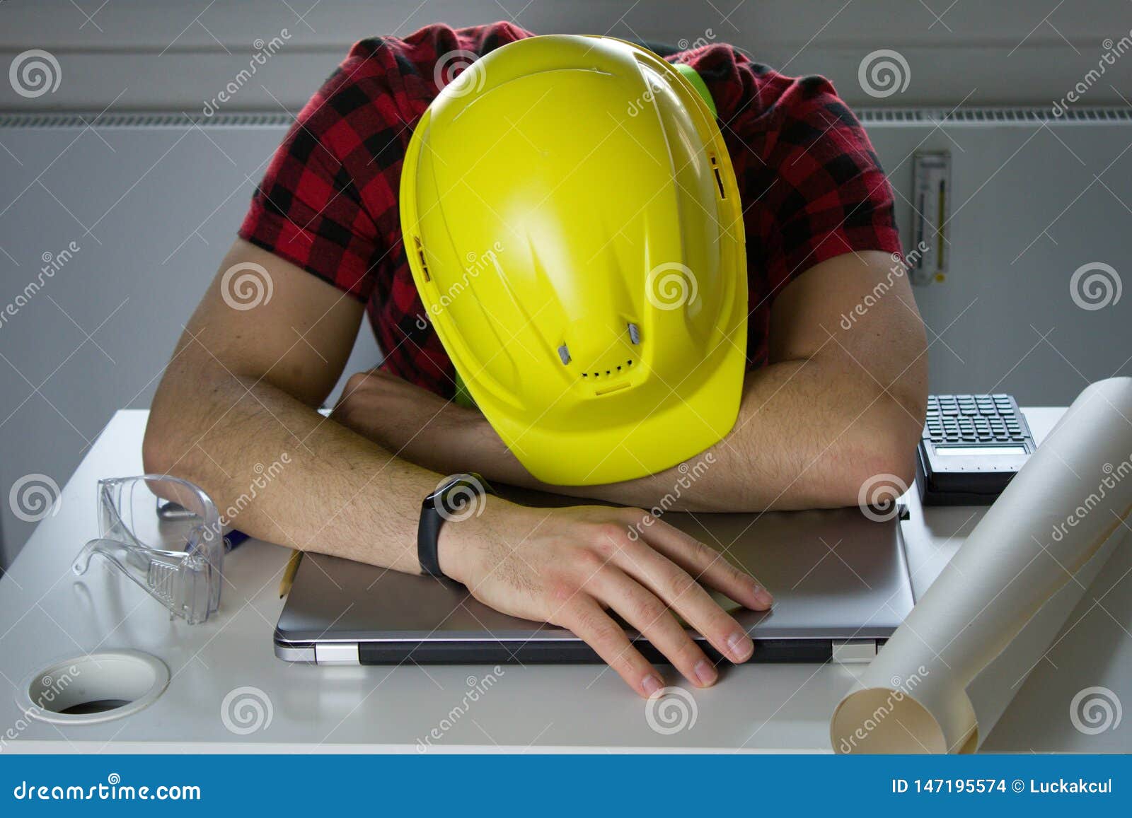 Bored Construction Worker is Lying on a Laptop Stock Photo - Image of ...
