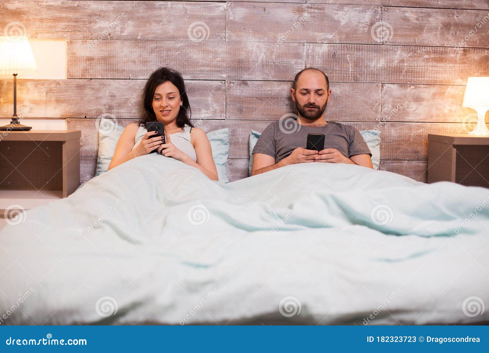 Bored Husband Browsing On Smartphone Before Bedtime Stock Image Image Of Relationship