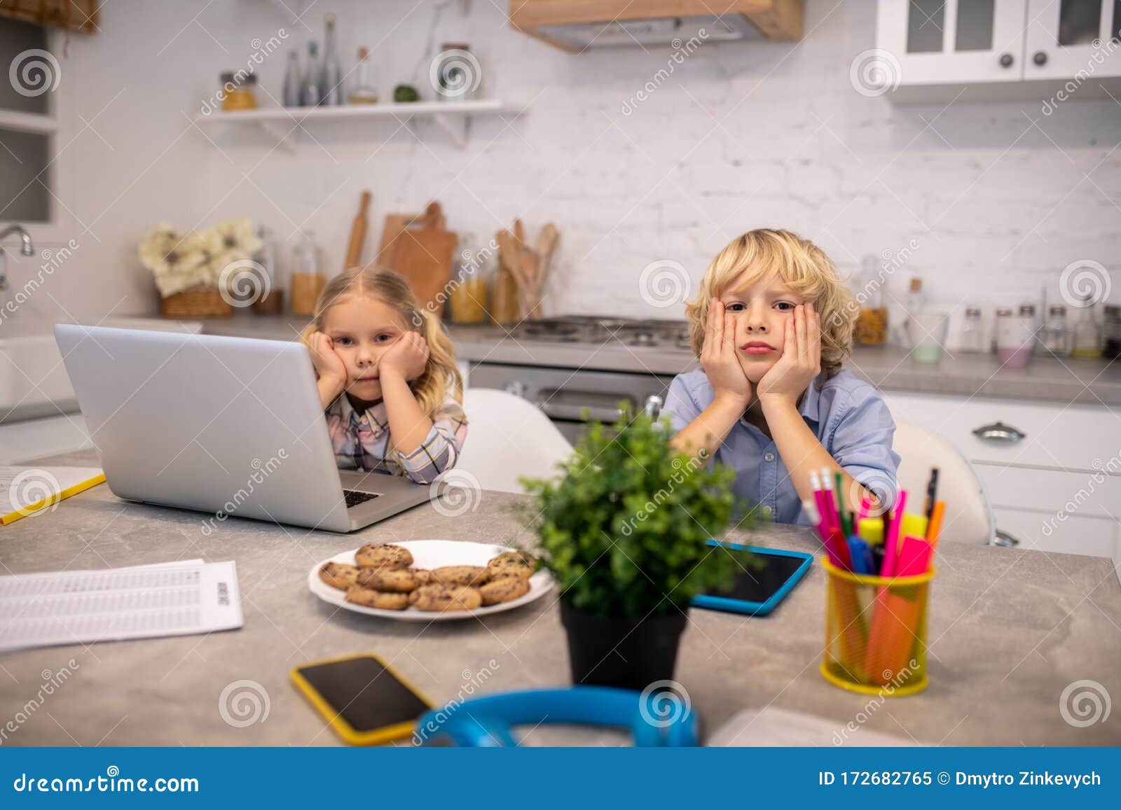 Two Kids Sitting at the Table and Looking Bored Stock Image - Image of ...
