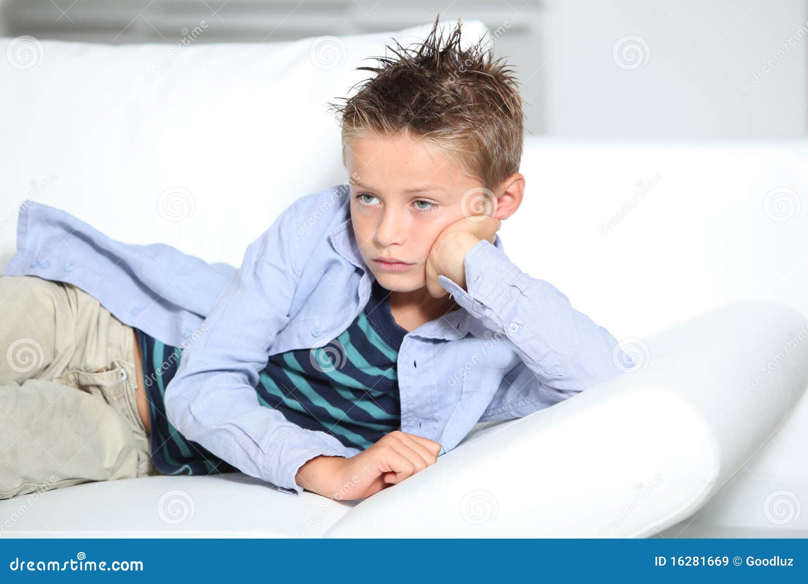 Bored little boy stock image. Image of young, home, sofa - 16281669