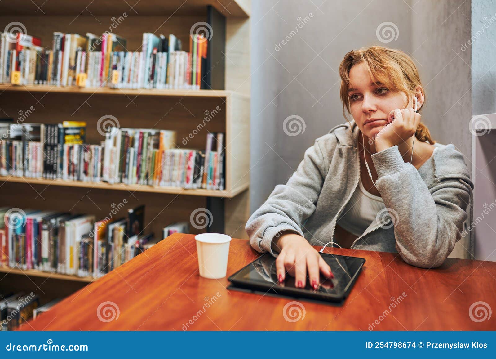 Bored Student Learning in University Library. Young Woman Listening To ...