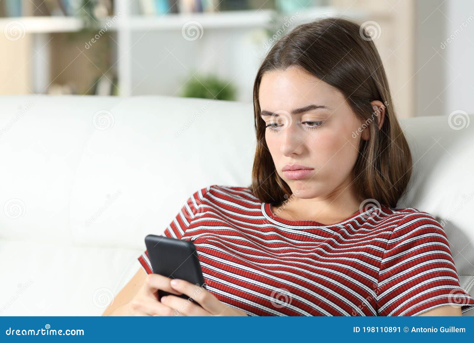 Bored Teen Checking Smart Phone on a Sofa Stock Image - Image of ...
