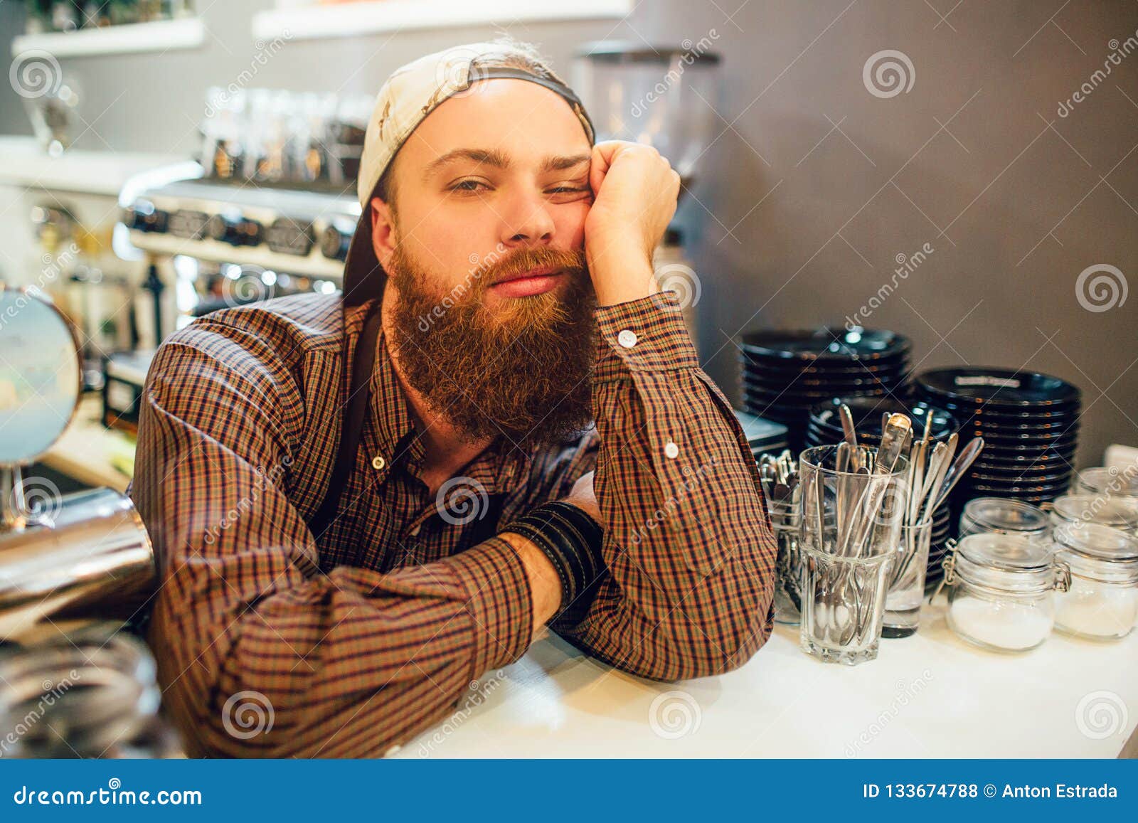 Bored Young Barista Lean at Table and Look on Camera. he Doesn`t Do Any ...