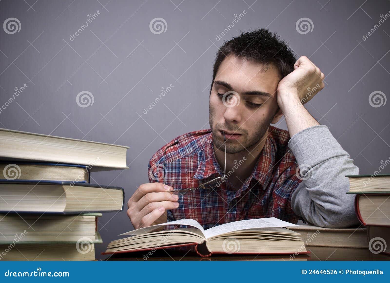 Bored Young Man Reading a Book Stock Photo - Image of research ...