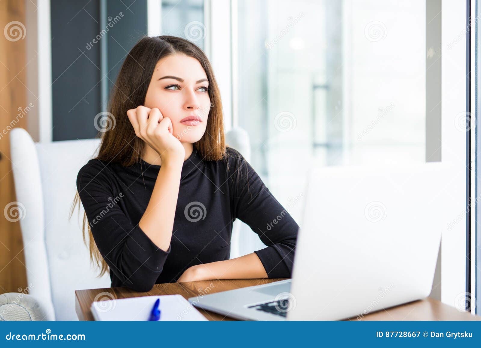 Bored Young Woman in the Office Working with a Laptop Stock Image ...
