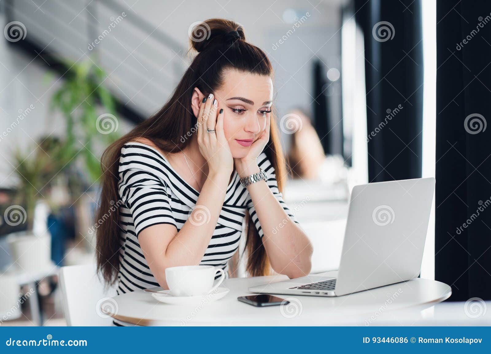 Bored Young Woman in the Office Working with a Laptop and Staring at ...