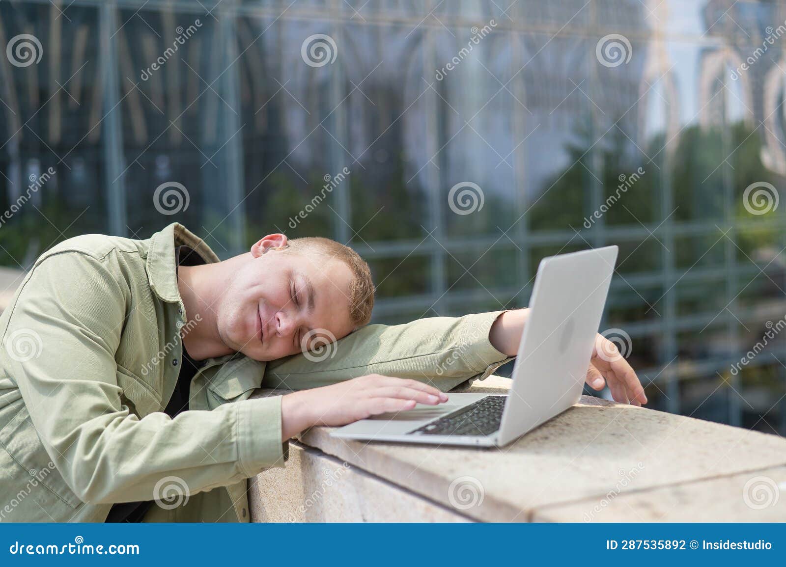 Boring Man with Hearing Aid Using Laptop Outdoors. Stock Photo - Image ...
