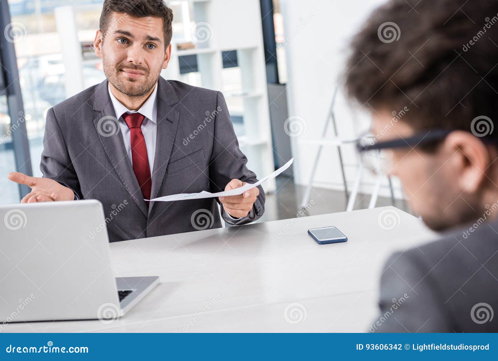 Boss with Documents Looking at Colleague at Business Meeting Stock ...