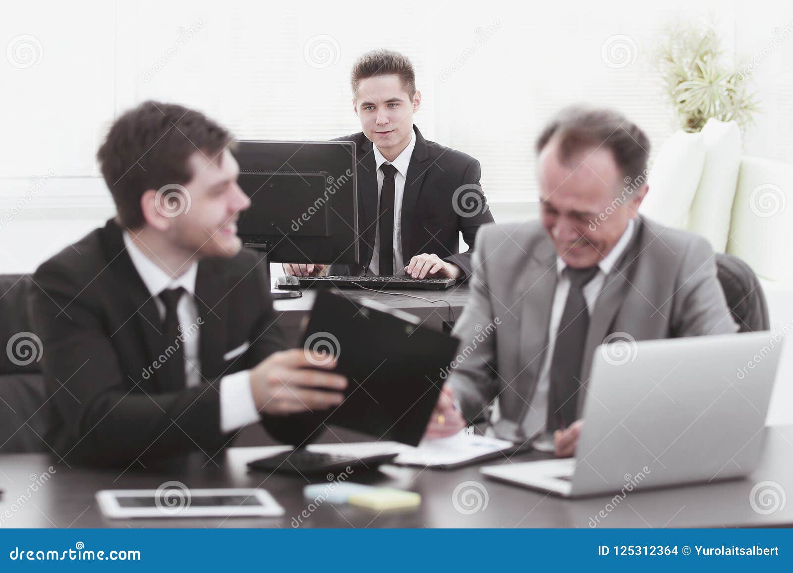 Boss and Employee Discussing the Document Sitting at the Desk in the ...