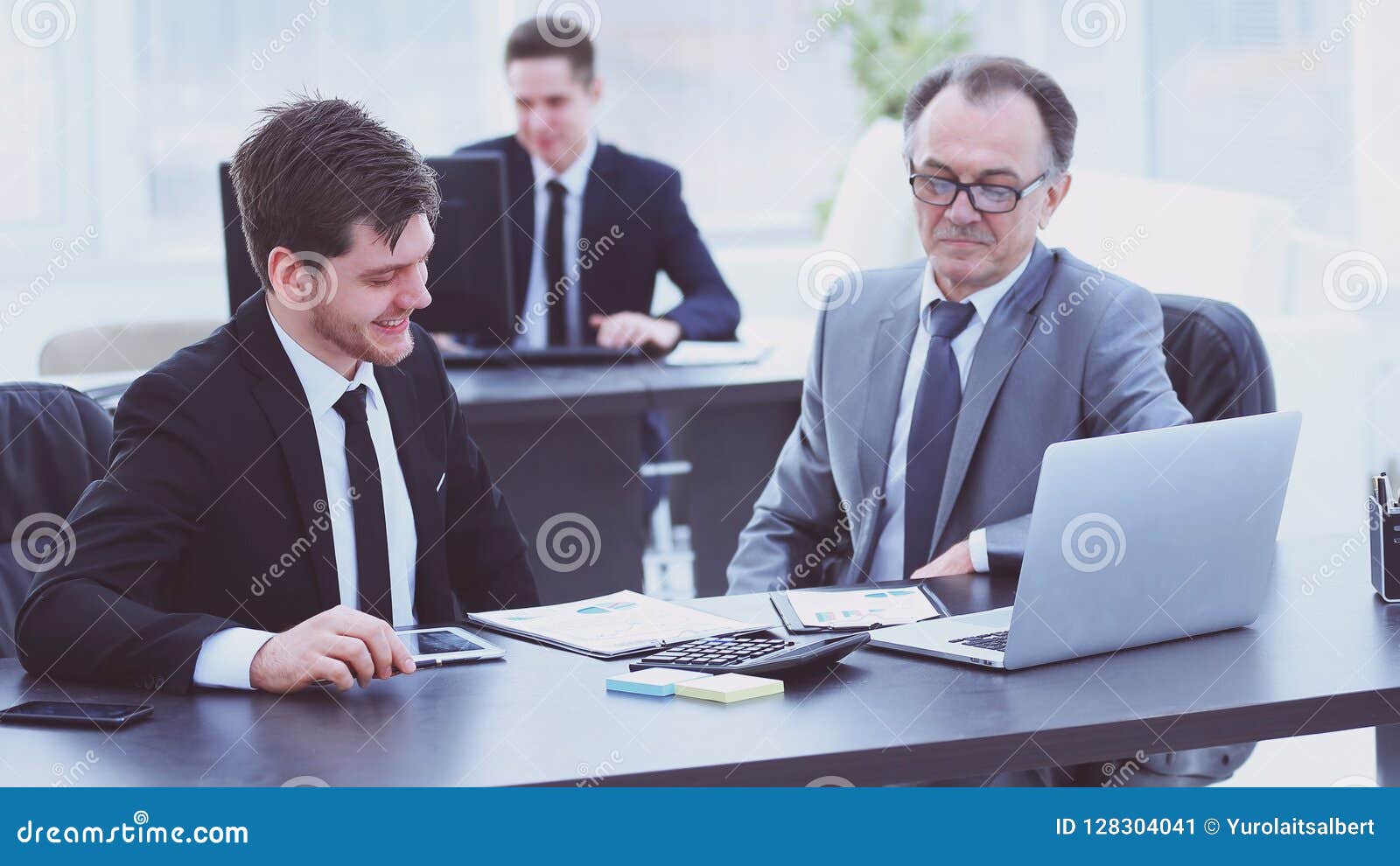 Boss and Employee Discussing the Document Sitting at the Desk in the ...