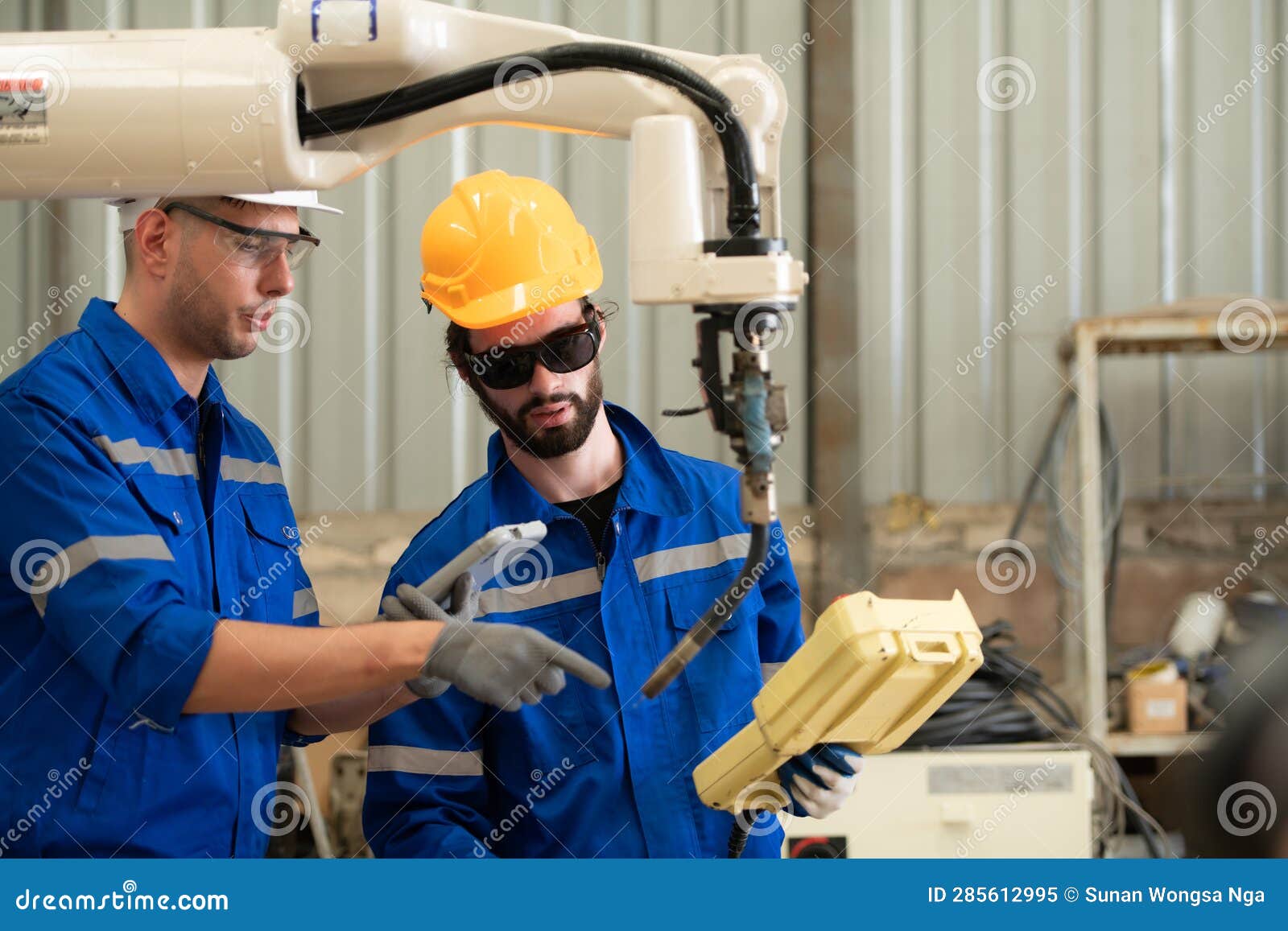 Both of Engineers are Manipulating a Welding Robot Hand. by Combining ...