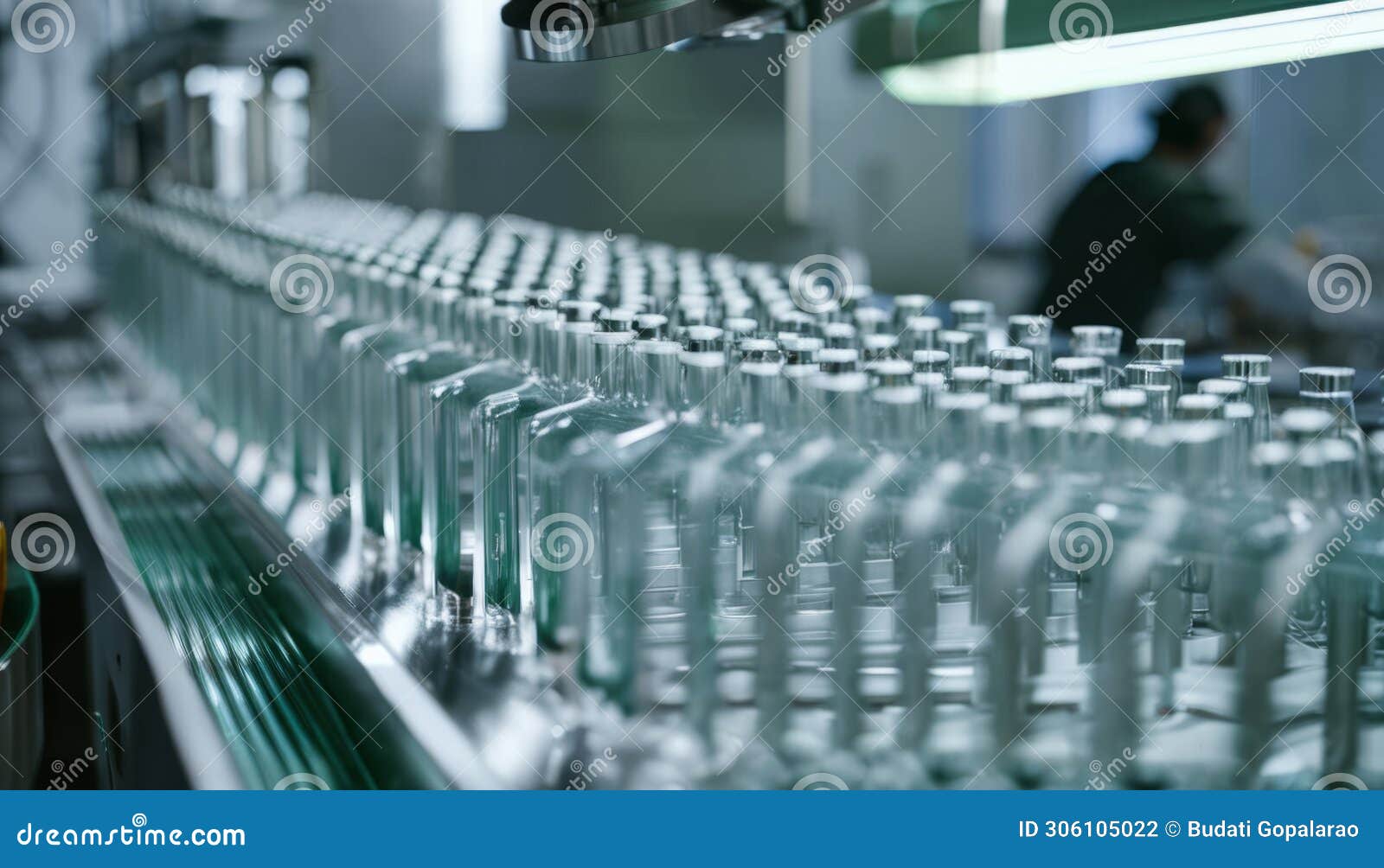 A Bottle Assembly Line with Many Bottles on a Conveyor Belt Stock ...