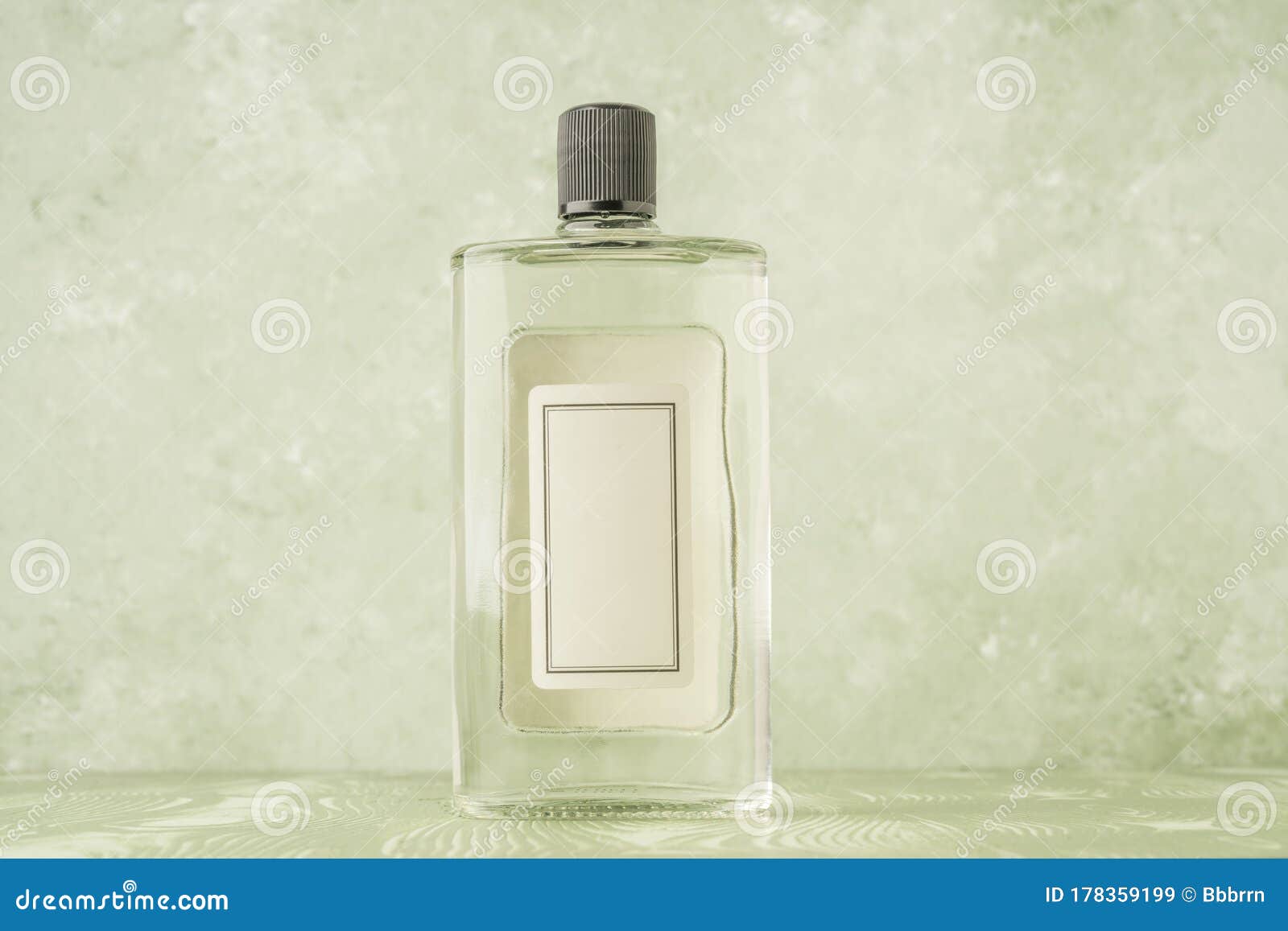 Bottle of Cologne with Empty Label Over Green Stock Image - Image of ...