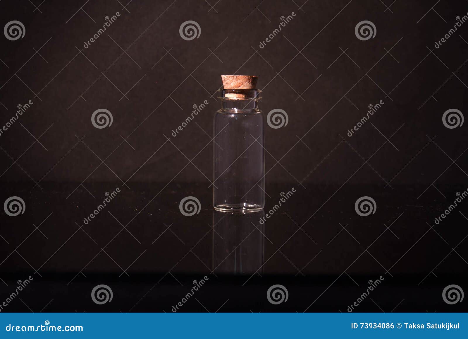 A bottle in the dark stock photo. Image of hand, minute - 73934086