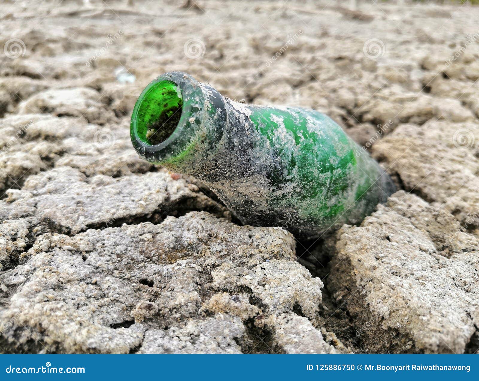 Bottle in Dried Cracked Mud. Stock Photo - Image of bottle, global ...