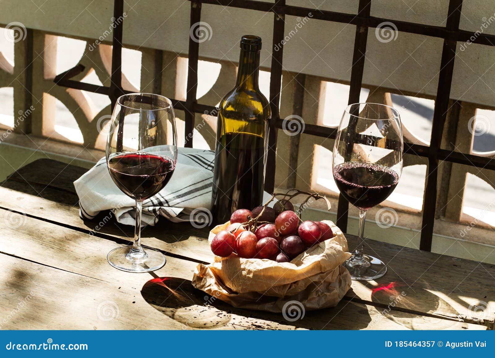 A Bottle and Glasses of Red Wine on a Rustic Table Stock Image - Image ...