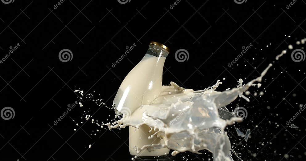 Bottle of Milk Exploding Against Black Background Stock Photo - Image ...