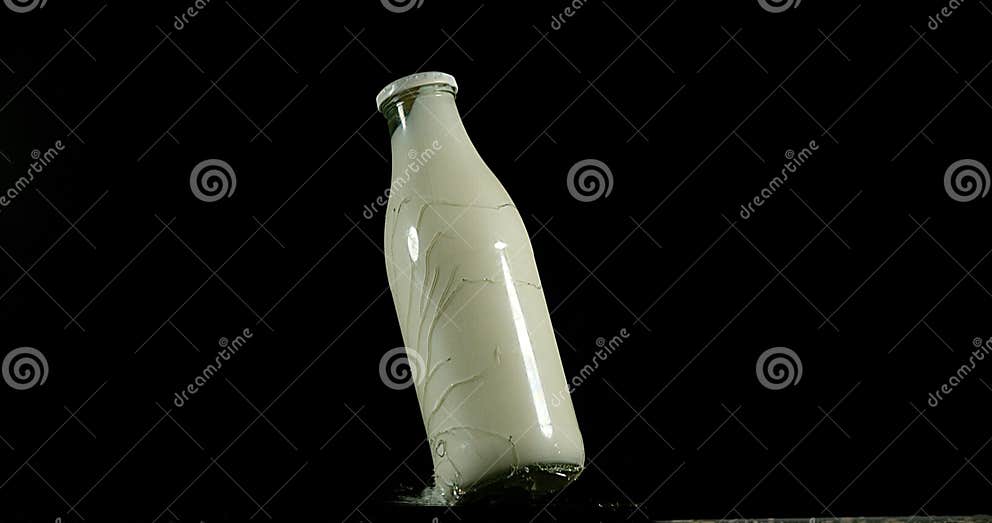 Bottle of Milk Exploding Against Black Background Stock Photo - Image ...