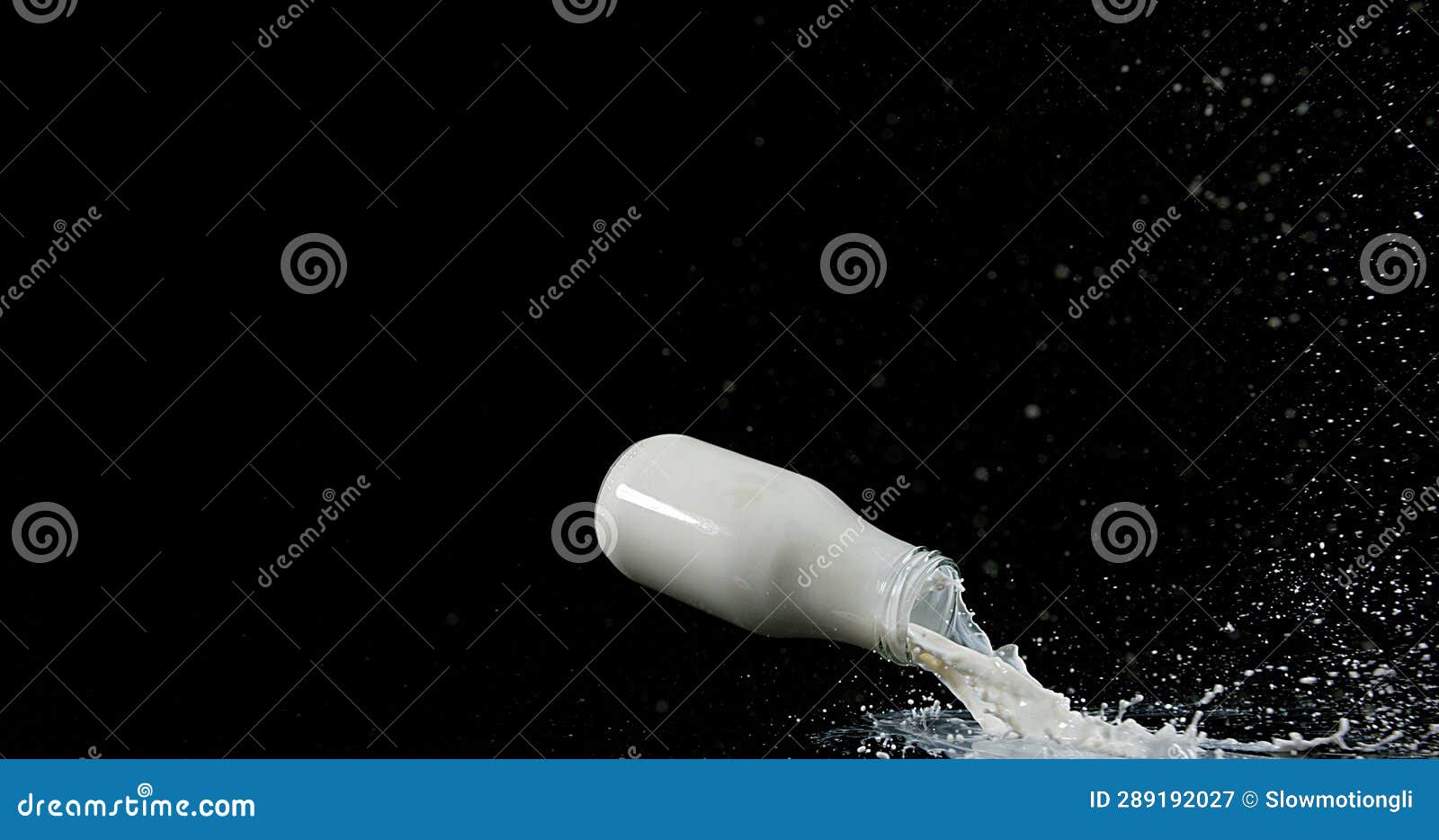 Bottle of Milk Falling and Exploging Against Black Background Stock ...