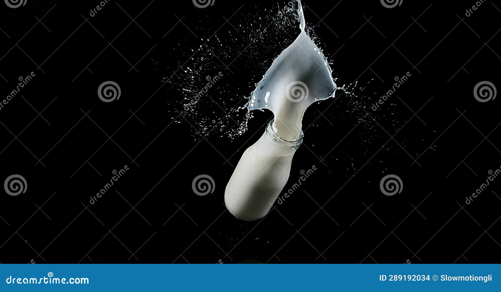 Bottle of Milk Falling and Exploging Against Black Background Stock ...