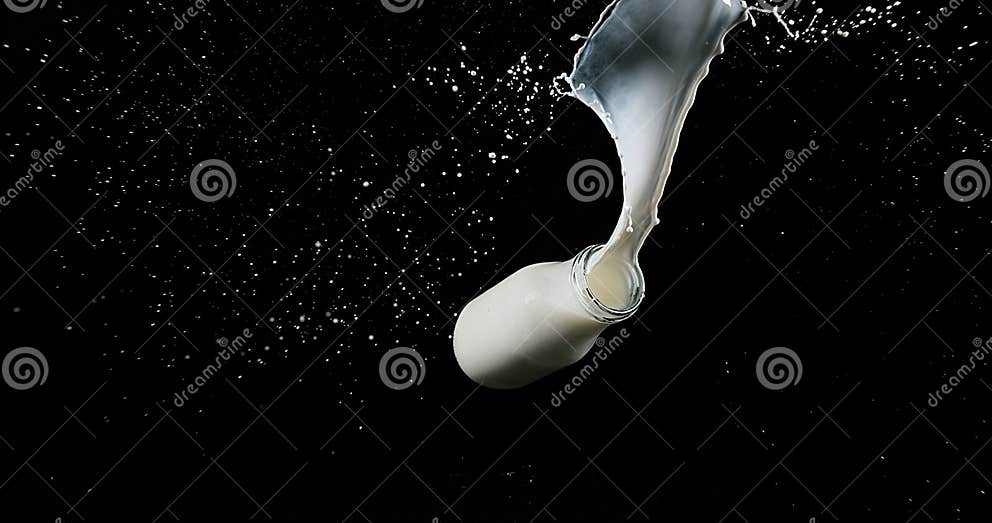 Bottle of Milk Falling and Exploging Against Black Background Stock ...