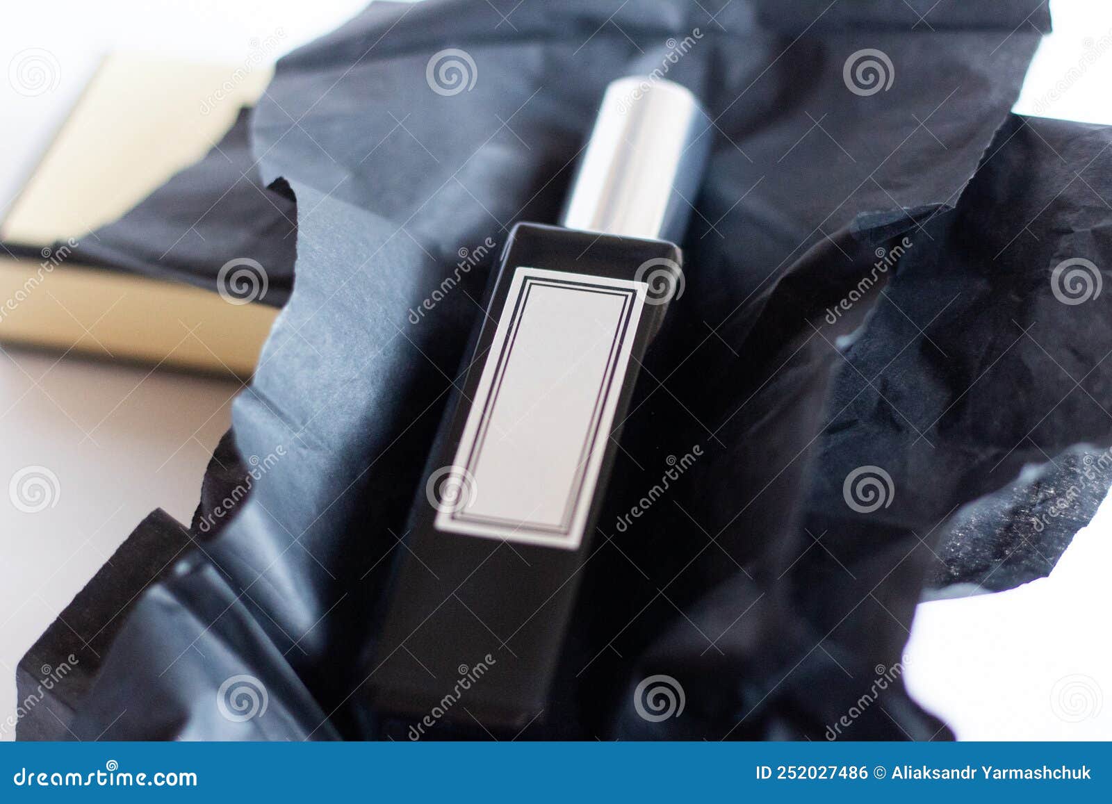 A Bottle of Perfume from a Yellow Box on a White Background Stock Photo ...