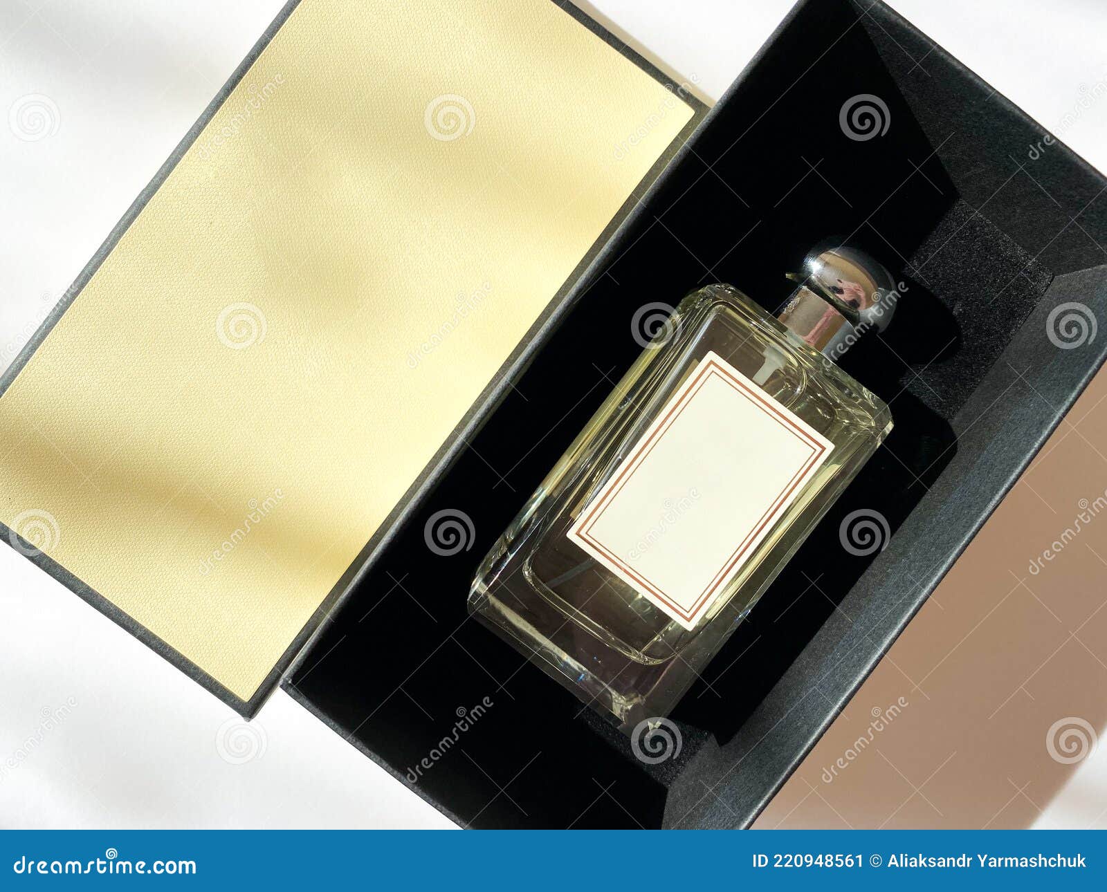 A Bottle of Perfume from a Yellow Box on a White Isolated Background ...