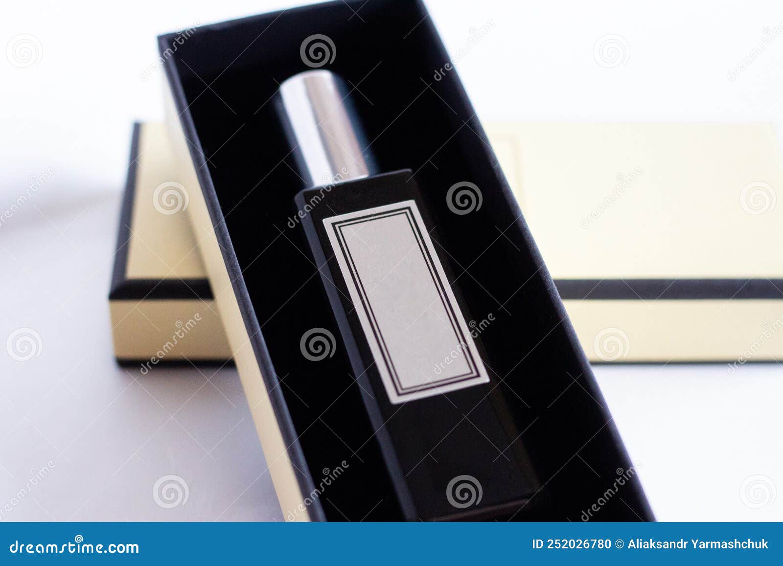 A Bottle of Perfume from a Yellow Box on a White Isolated Background ...