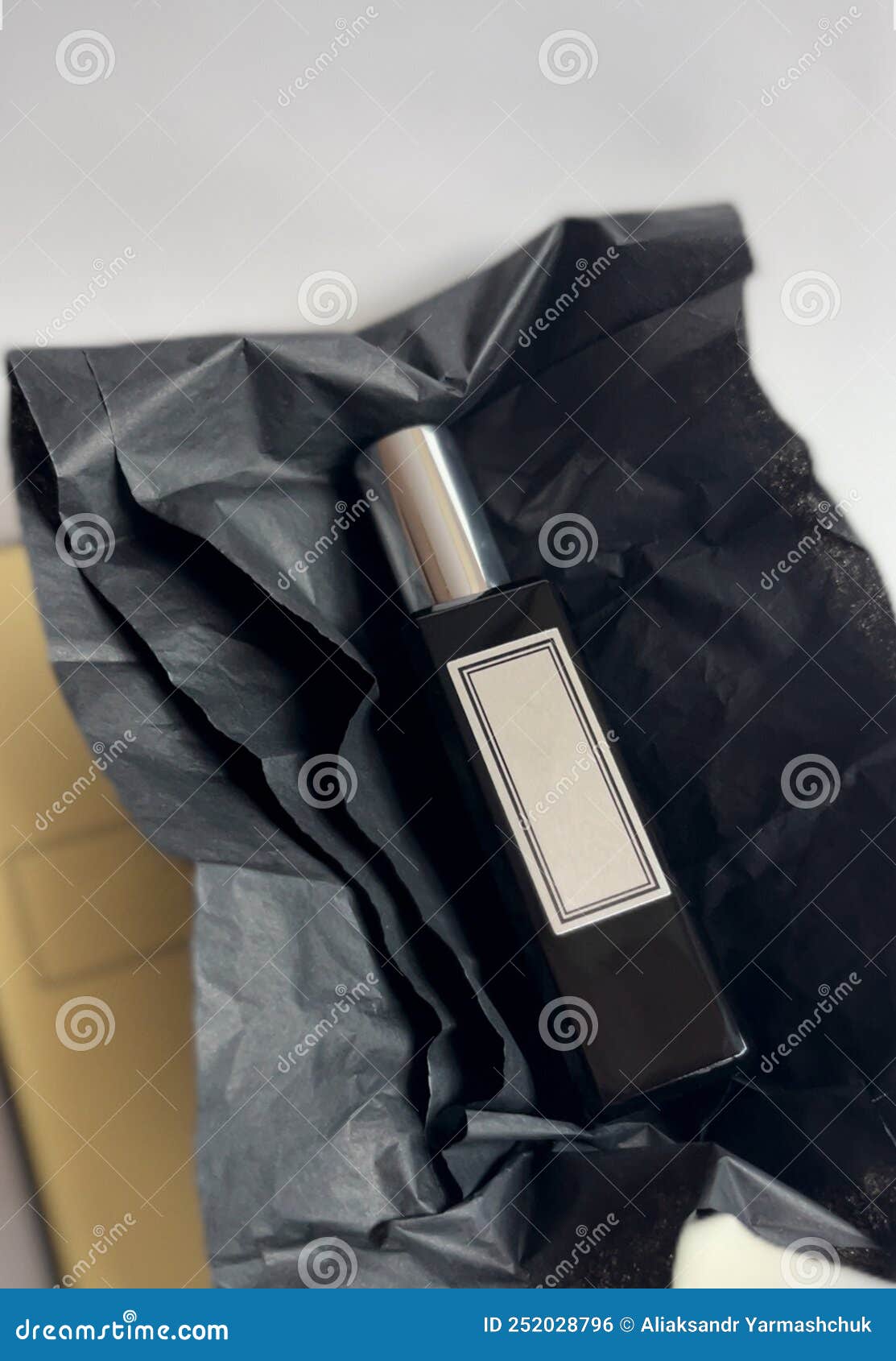 A Bottle of Perfume from a Yellow Box on a White Isolated Background ...