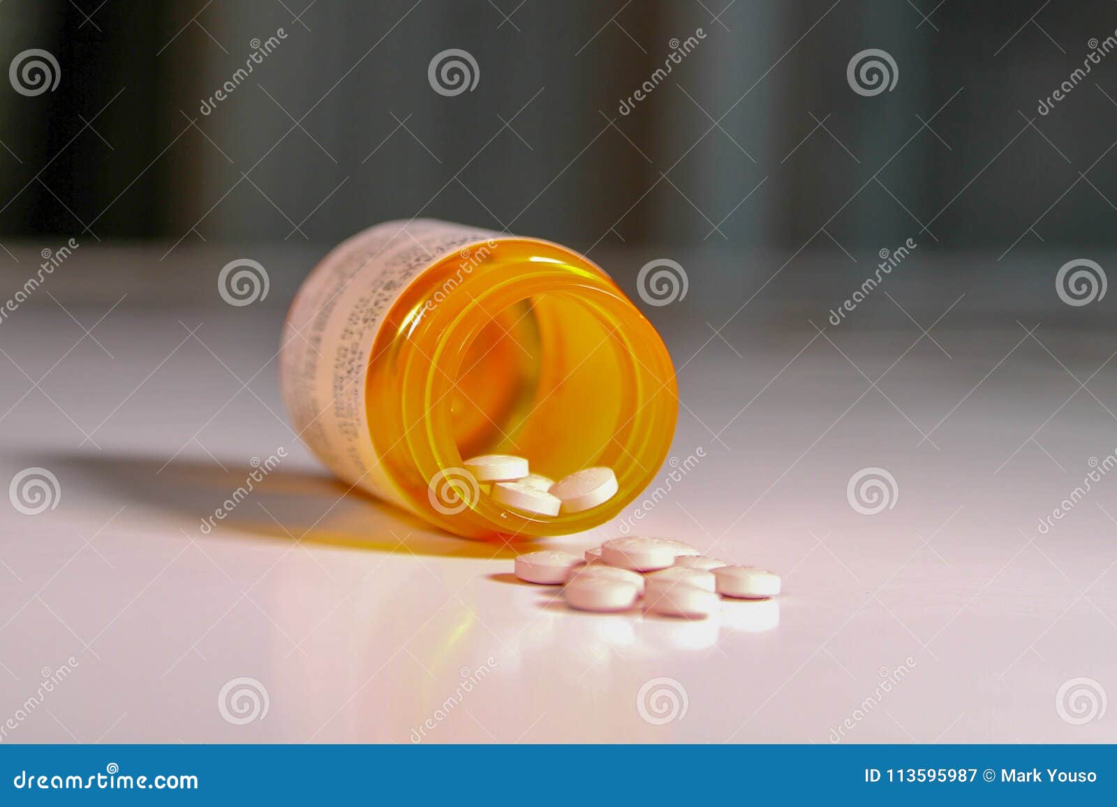 Medication Bottle And Bright Pink Pills Spilled On Dark Blue Coloured ...