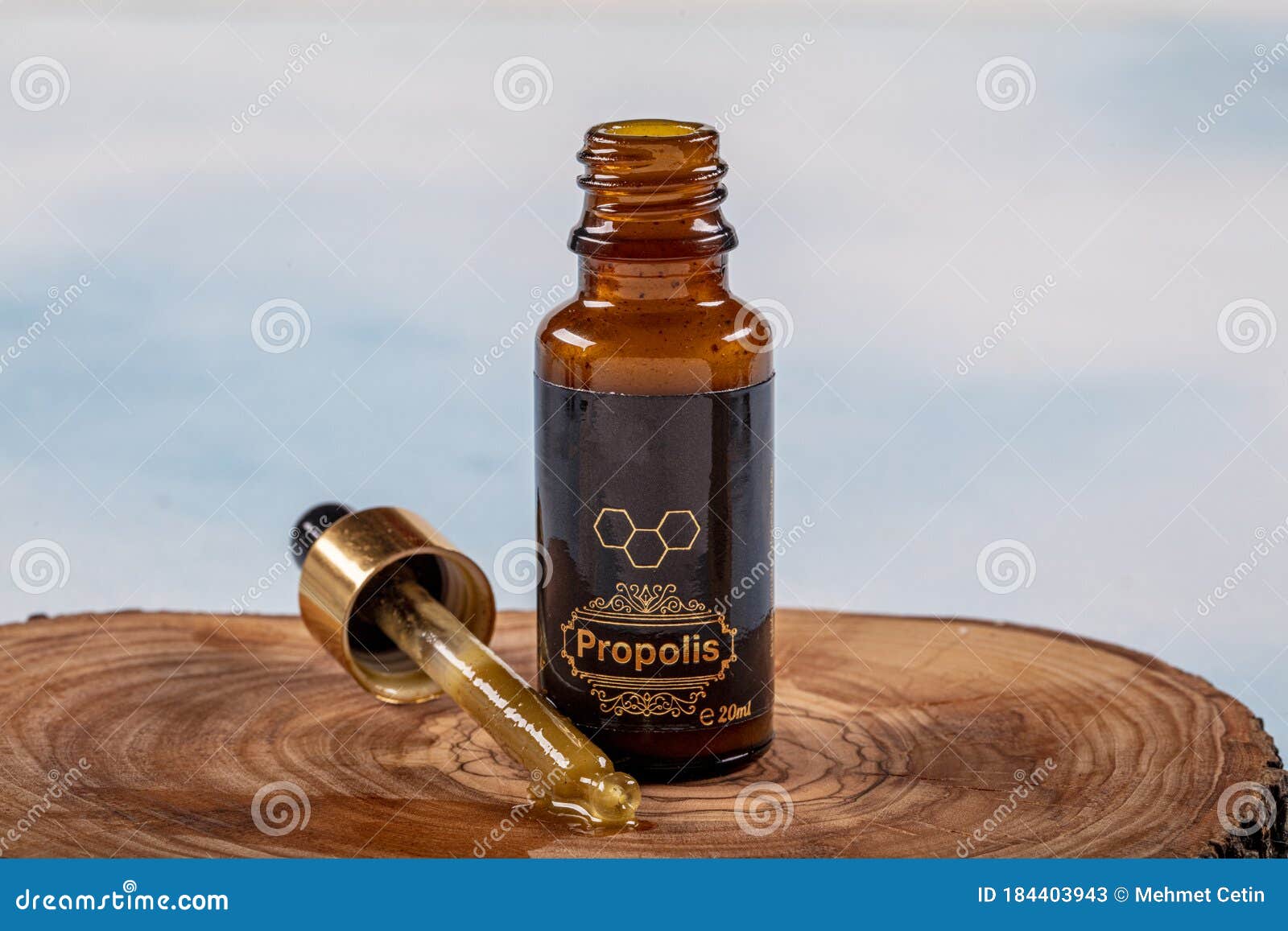 A Bottle of Propolis on Piece of Wood Propolis Drop Oil Drop Falling ...