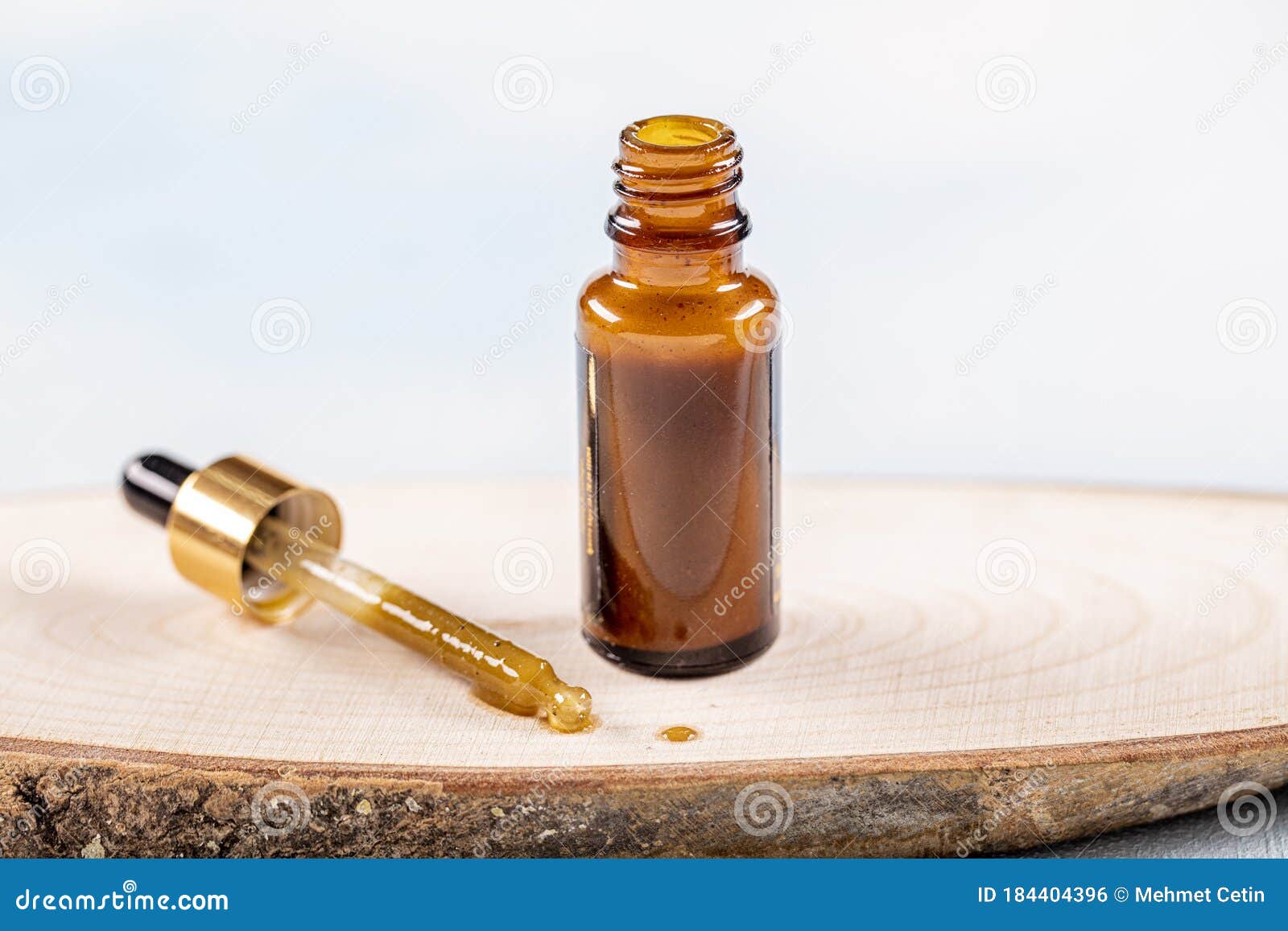 A Bottle of Propolis on Piece of Wood Propolis Drop Oil Drop Falling ...