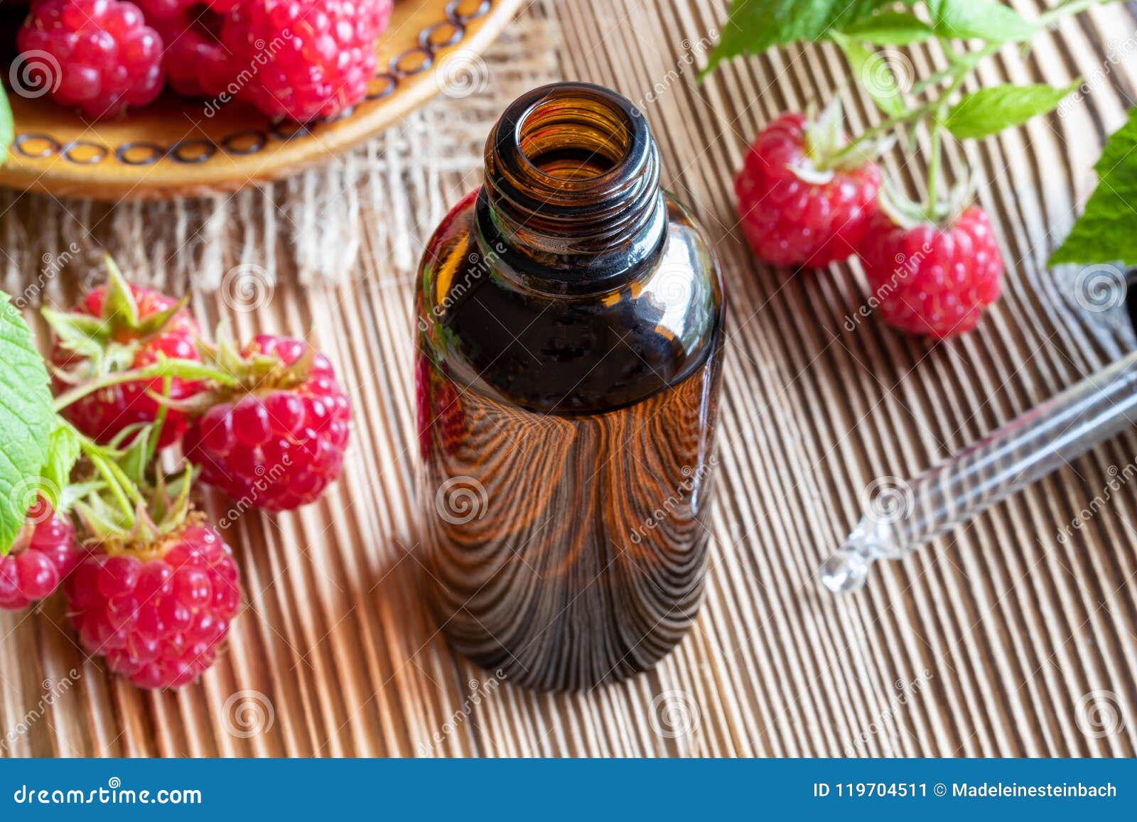 A Bottle of Raspberry Seed Oil with Fresh Raspberries Stock Image ...