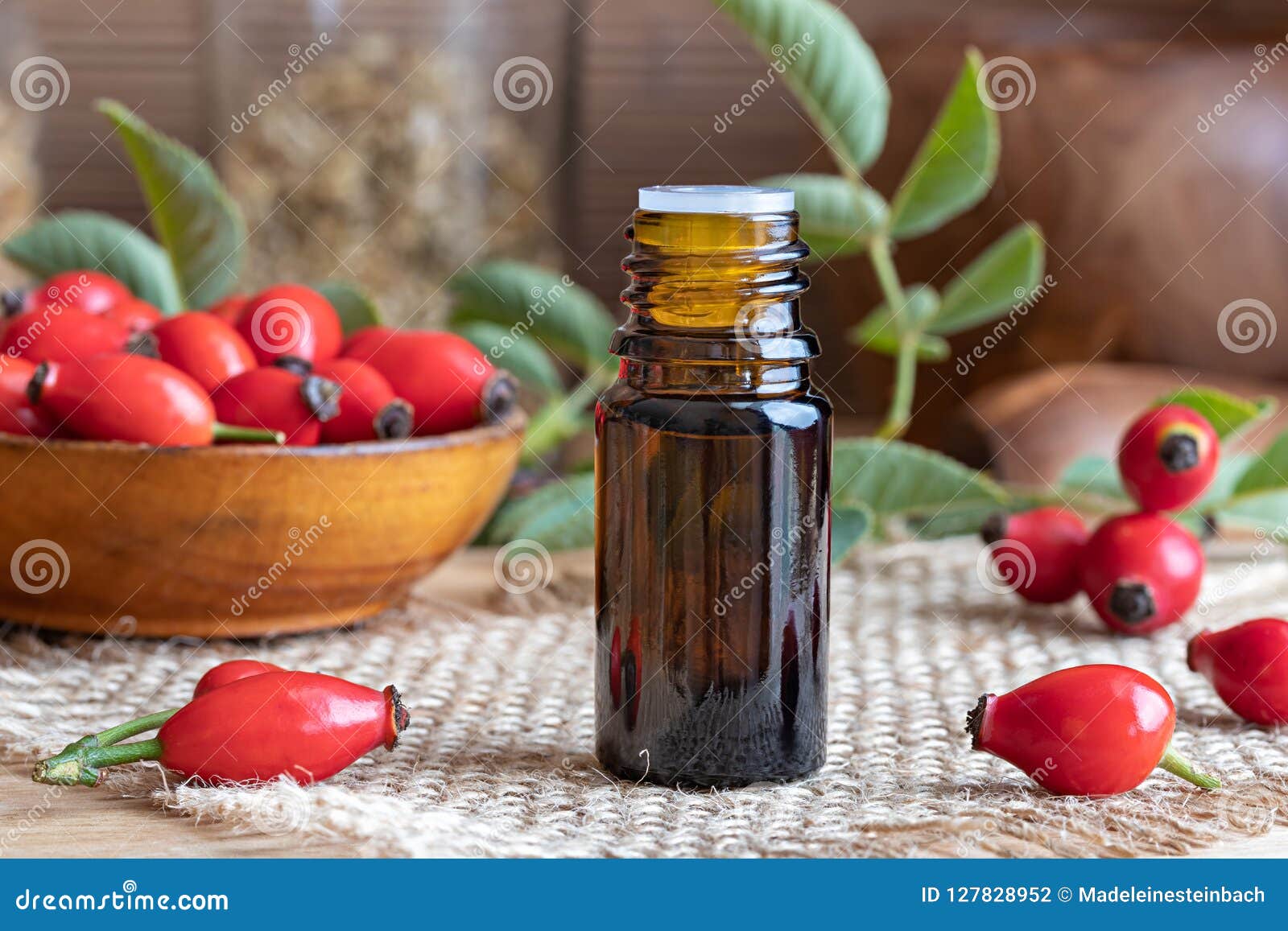 A Bottle of Rosehip Seed Oil with Fresh Rosehips Stock Photo - Image of ...