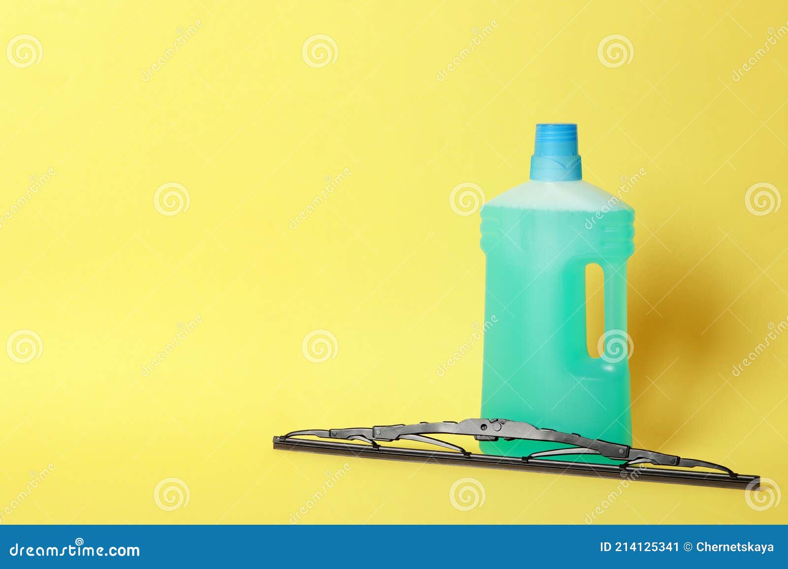Bottle of Windshield Washer Fluid and Wiper on Yellow Background. Space ...