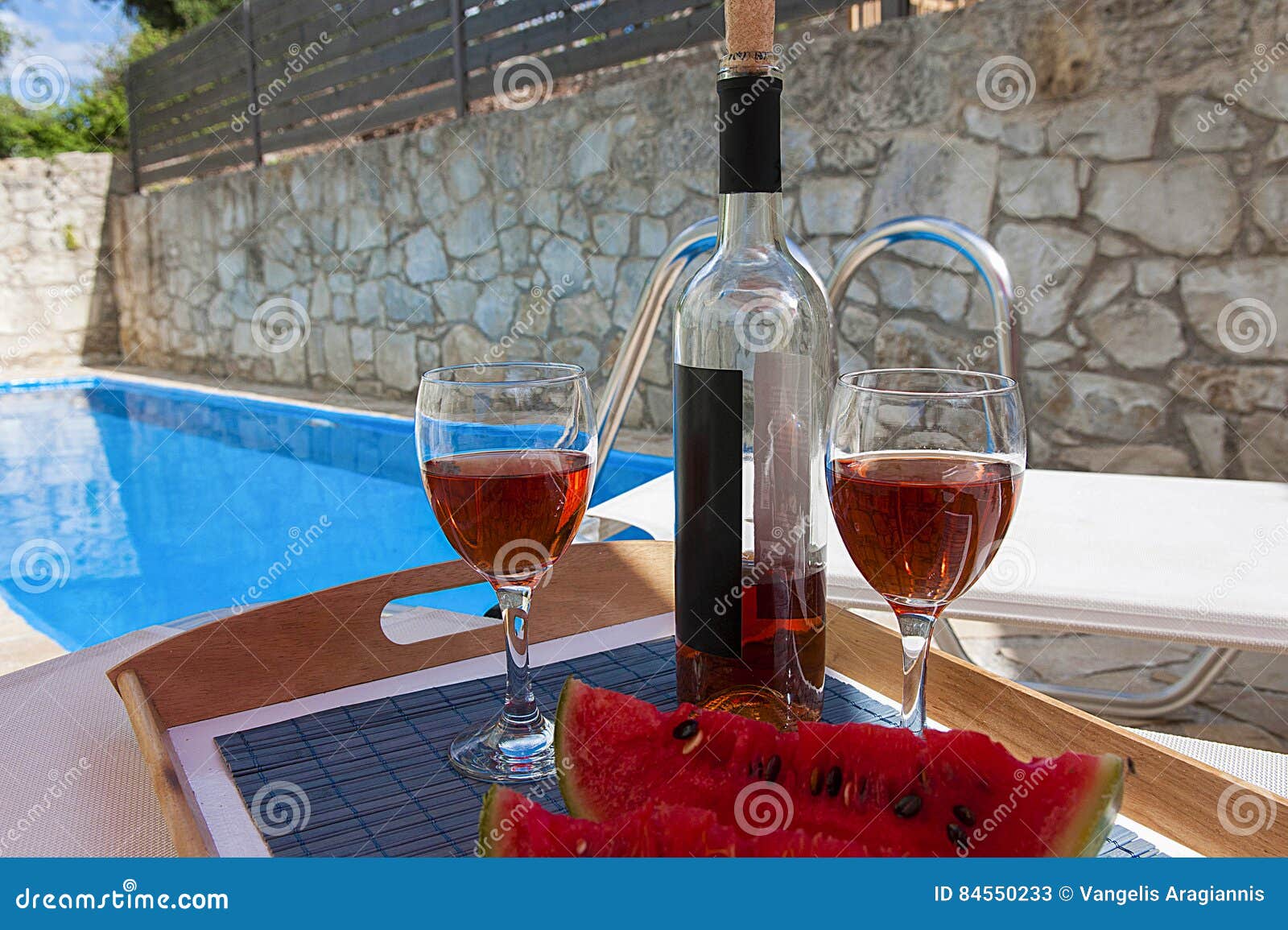Bottle of wine at poolside stock image. Image of honeymoon - 84550233