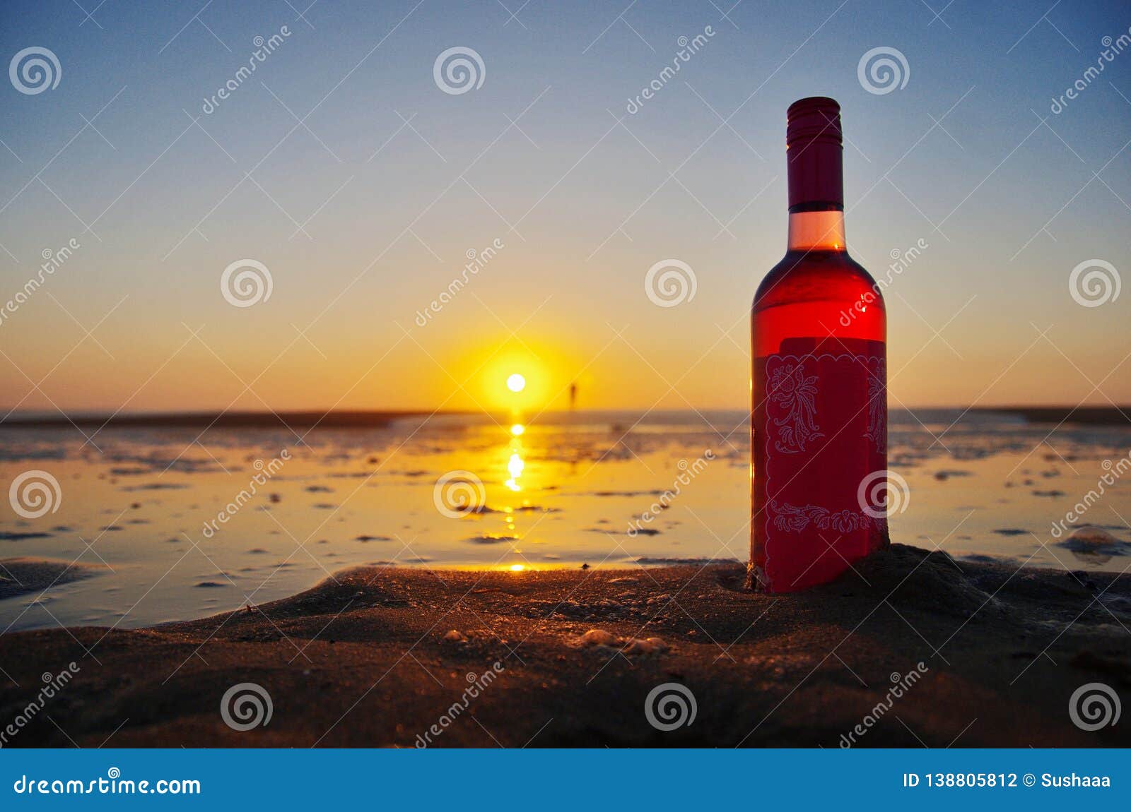 Bottle of Wine in the Sand on the Beach. Sunset in the Background ...