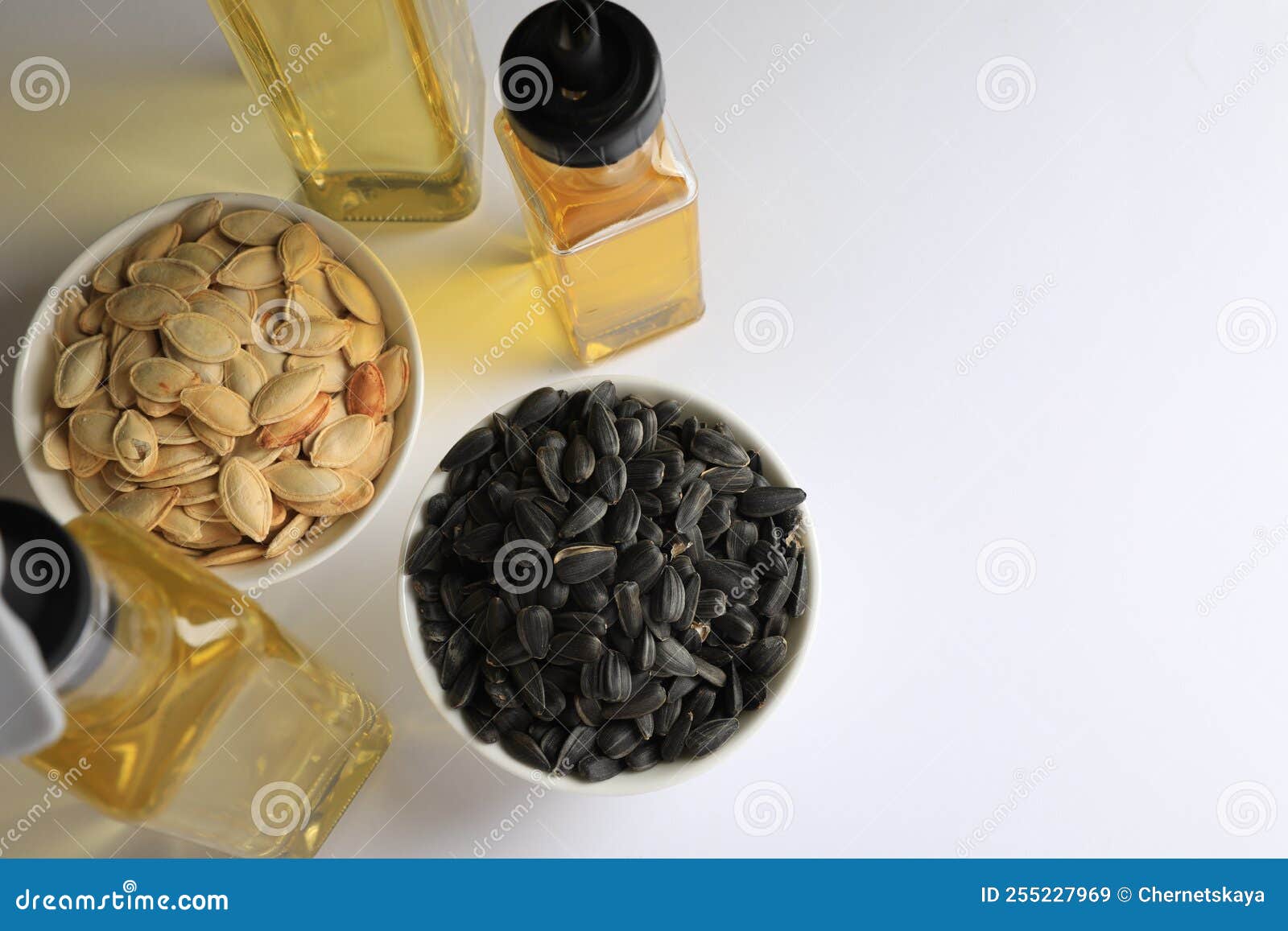 Bottles of Different Cooking Oils and Seeds on White Background, Above ...
