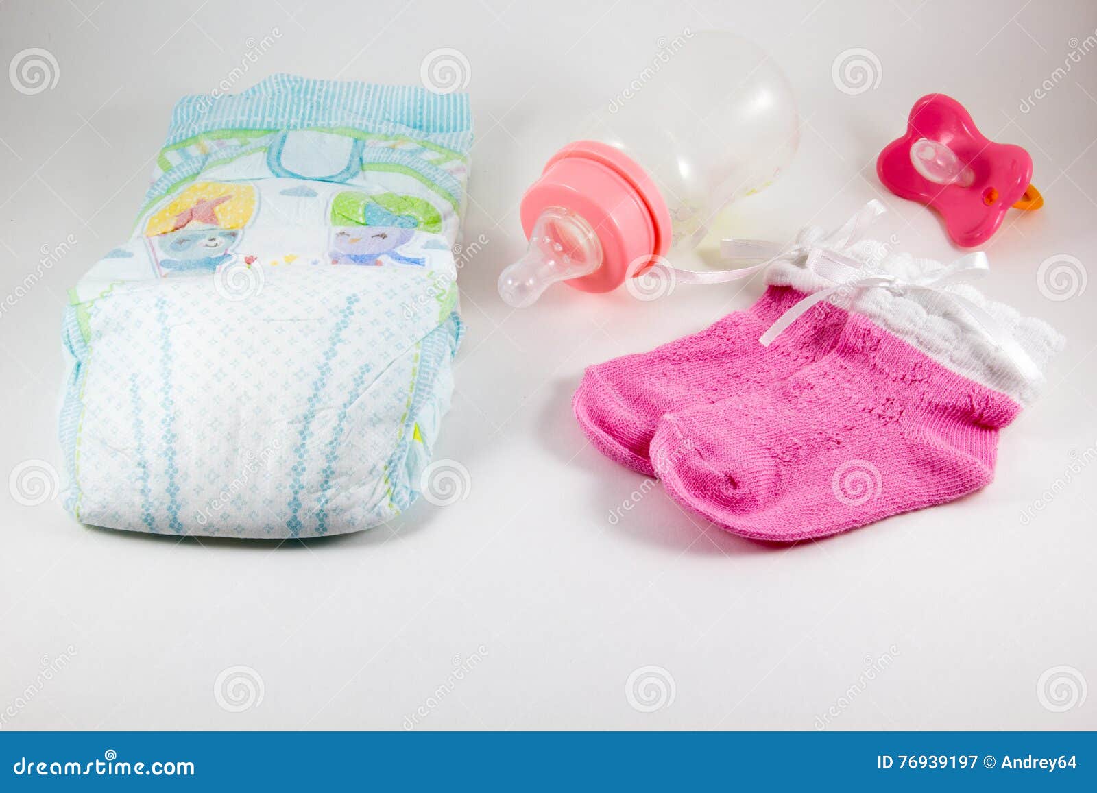 Bottles, Pacifiers, and Baby Diaper on a White Background Stock Image ...