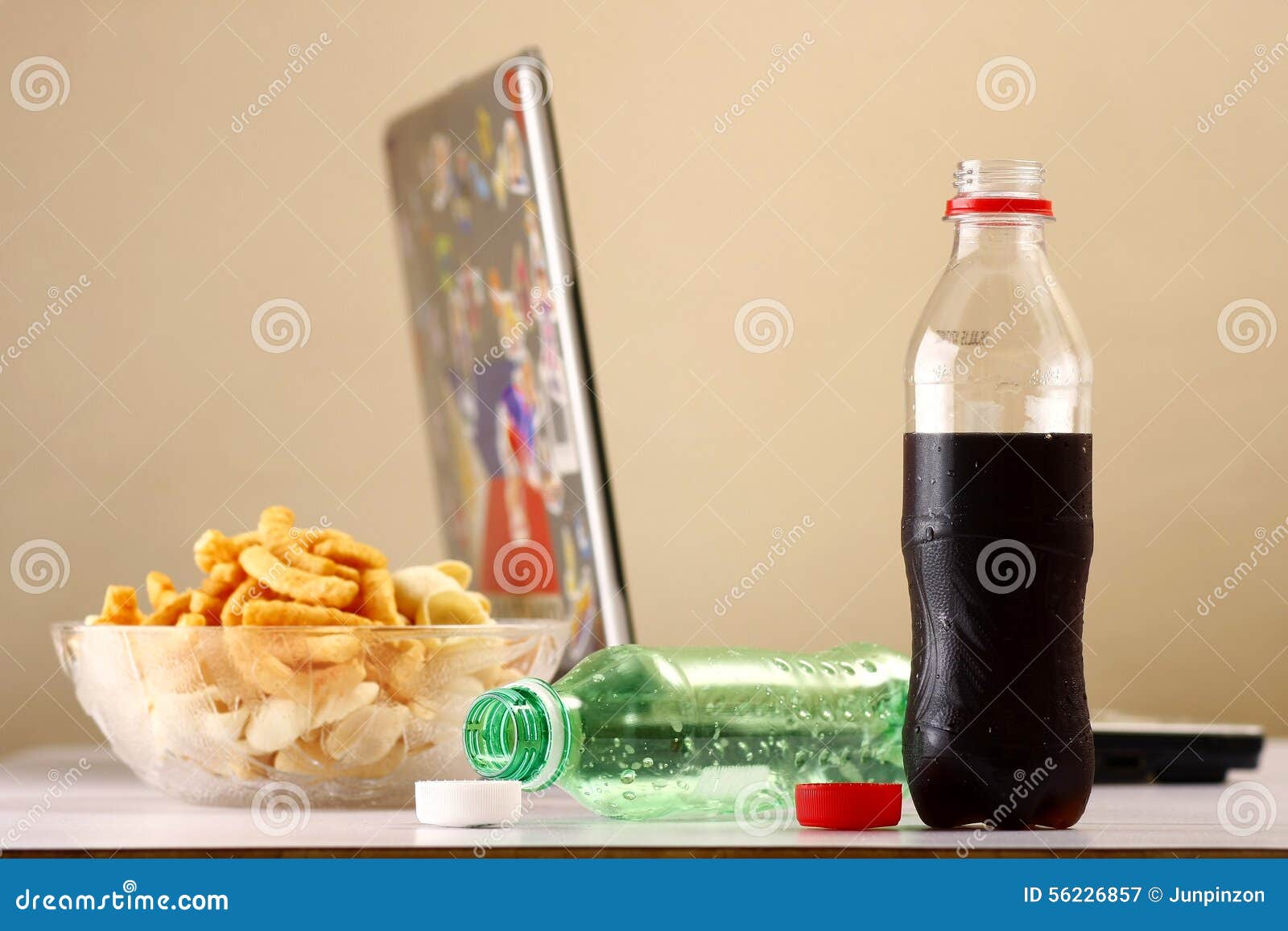 Bottles Of Softdrinks Or Soda, Chips And Man Using A Smartphone Anda ...