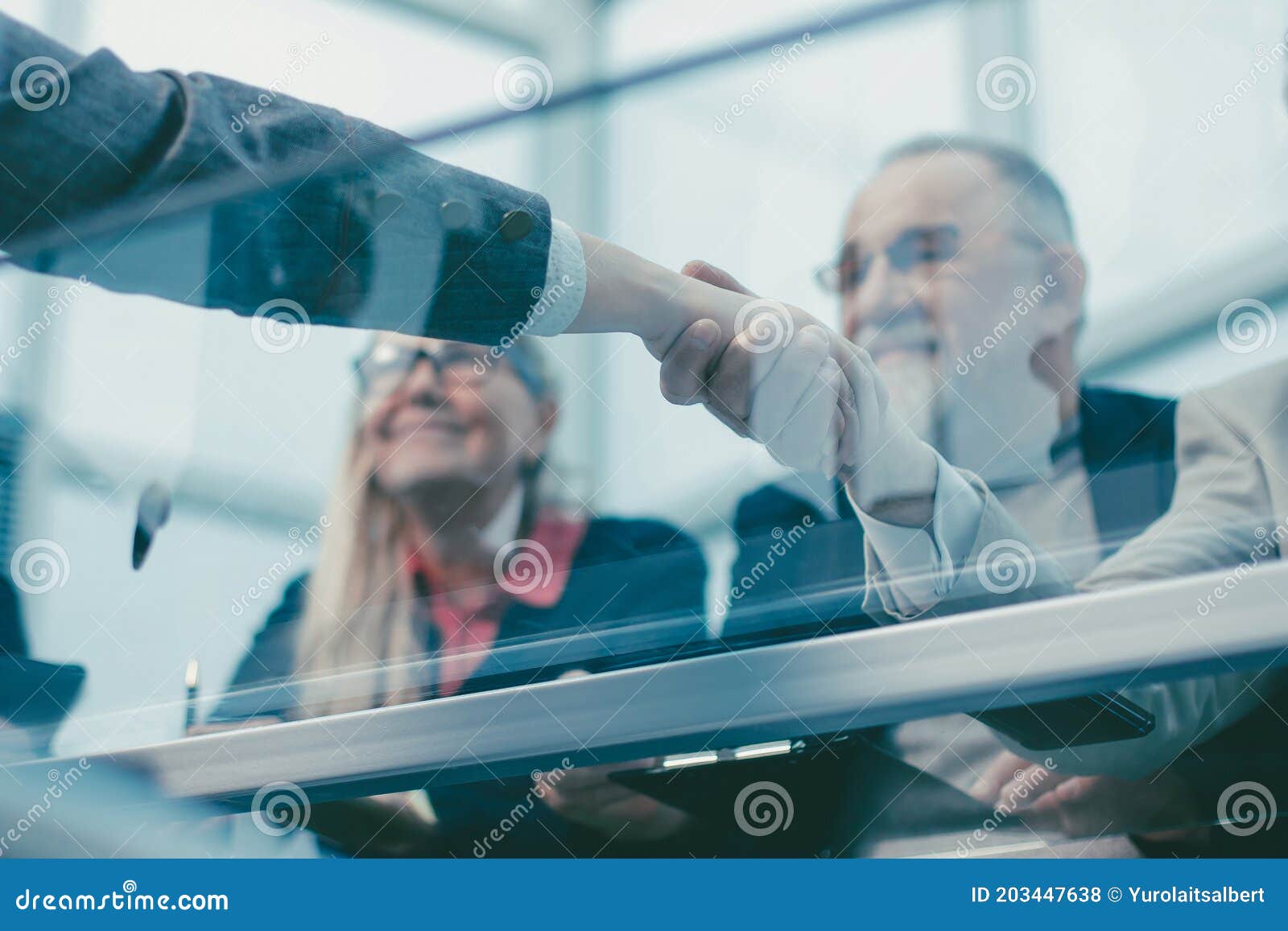 Bottom View. Business Handshake Over the Negotiating Table Stock Photo ...