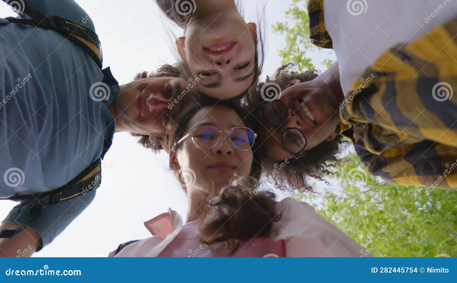 Bottom View of Diverse Friends Looking Down at Camera Outdoors Stock ...