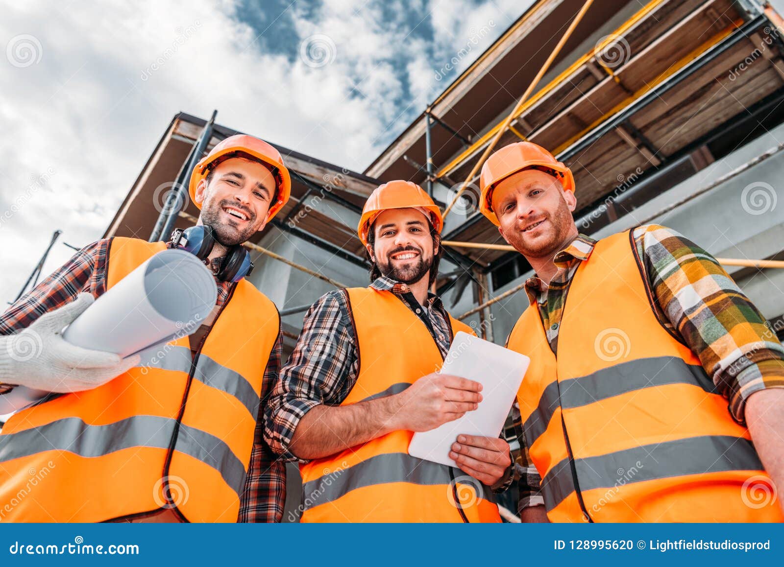 Bottom View of Group of Builders with Blueprint and Tablet Looking at ...