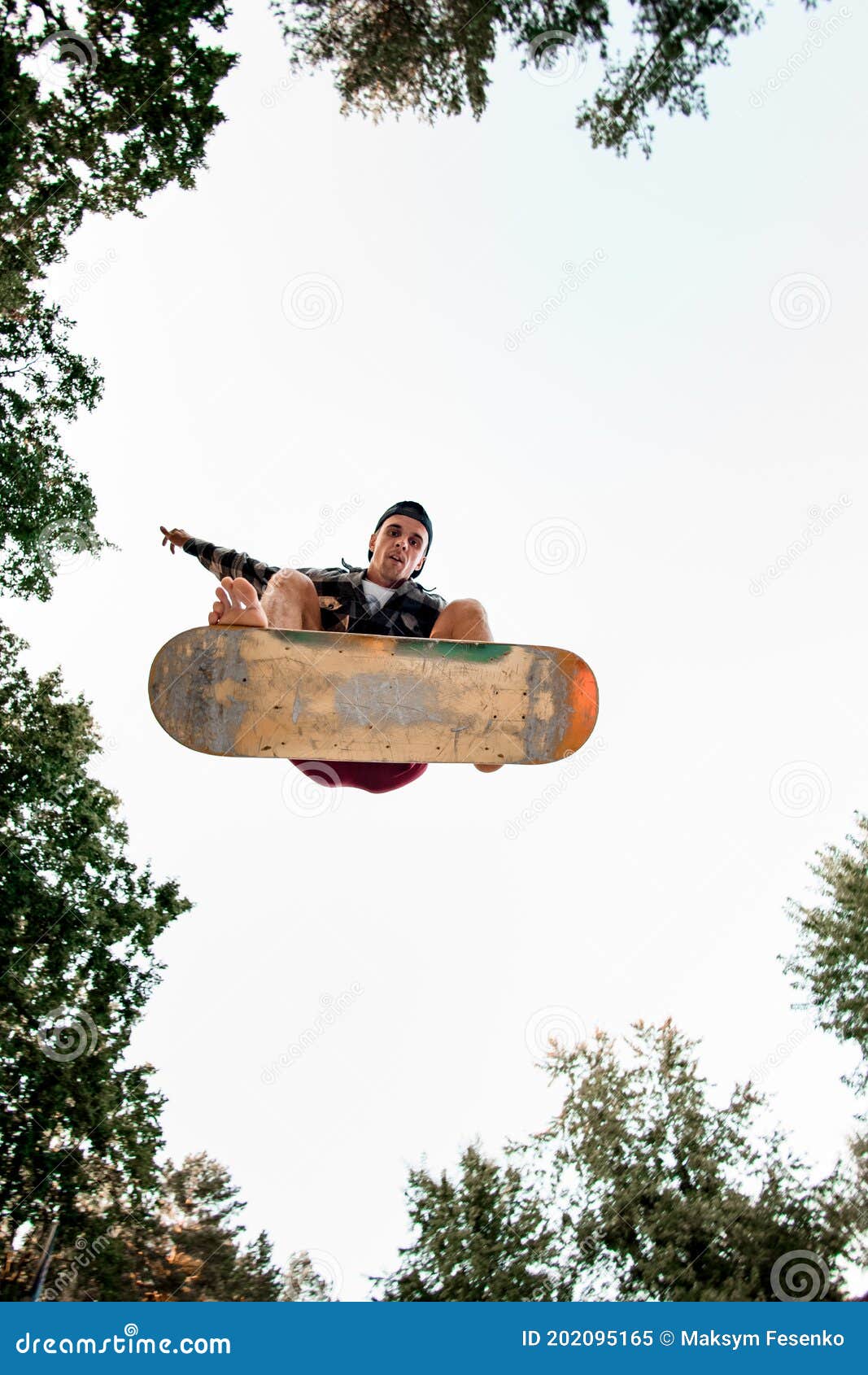 Bottom View of Guy with Skate Simulator Jumping Up Against Background ...